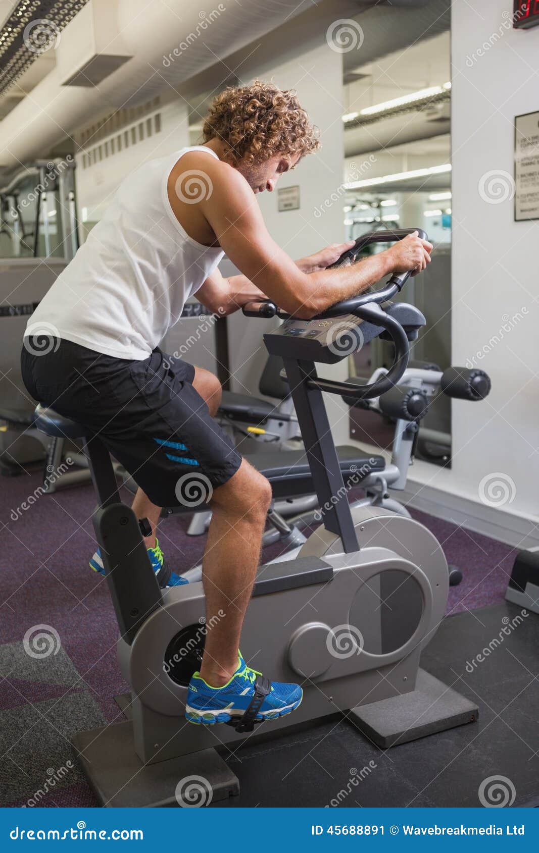 Side View of Man Working Out on Exercise Bike at Gym Stock Image ...