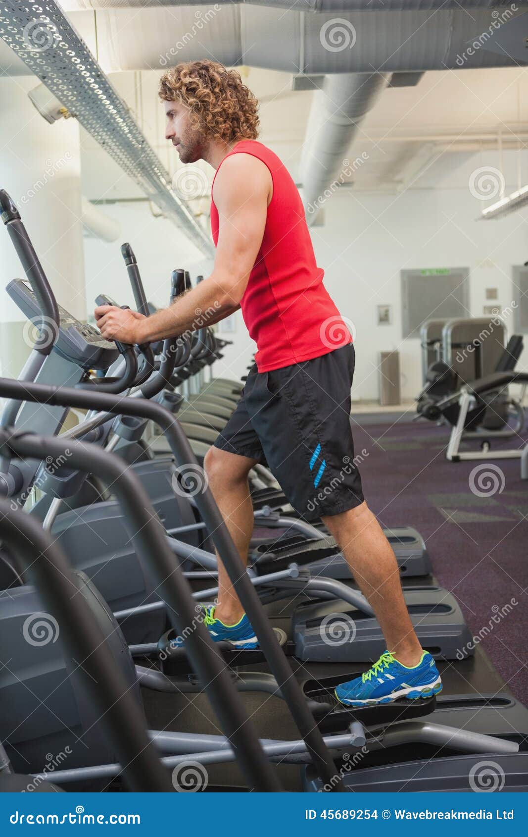 Side View of Man Working Out on X-trainer in Gym Stock Photo - Image of ...