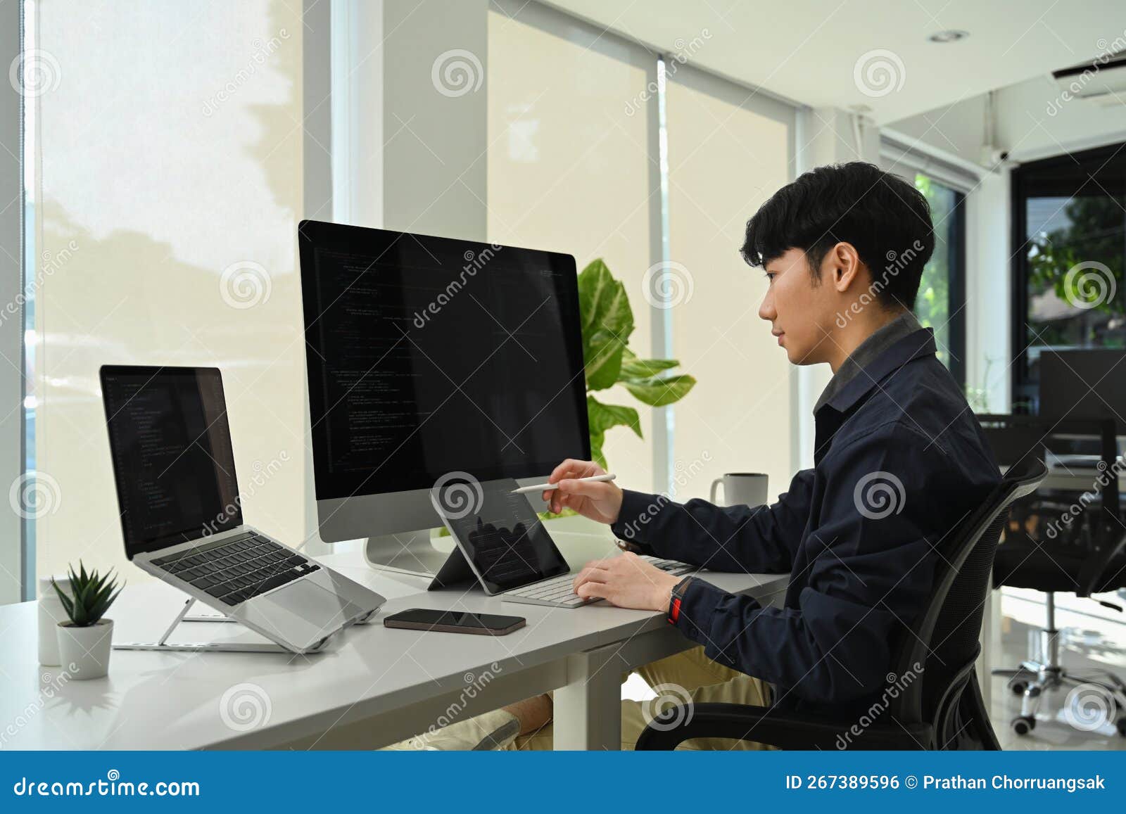 Side View of Man Working on Software Development on Desktop Computer at ...