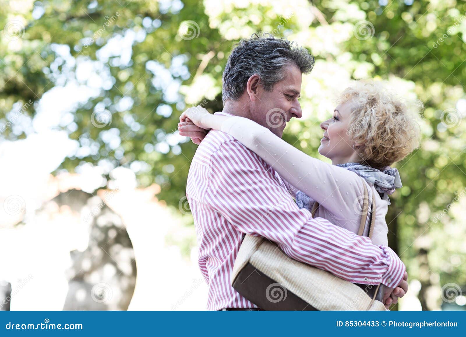 Side View of Middle-aged Couple Embracing while Looking at Each Other ...