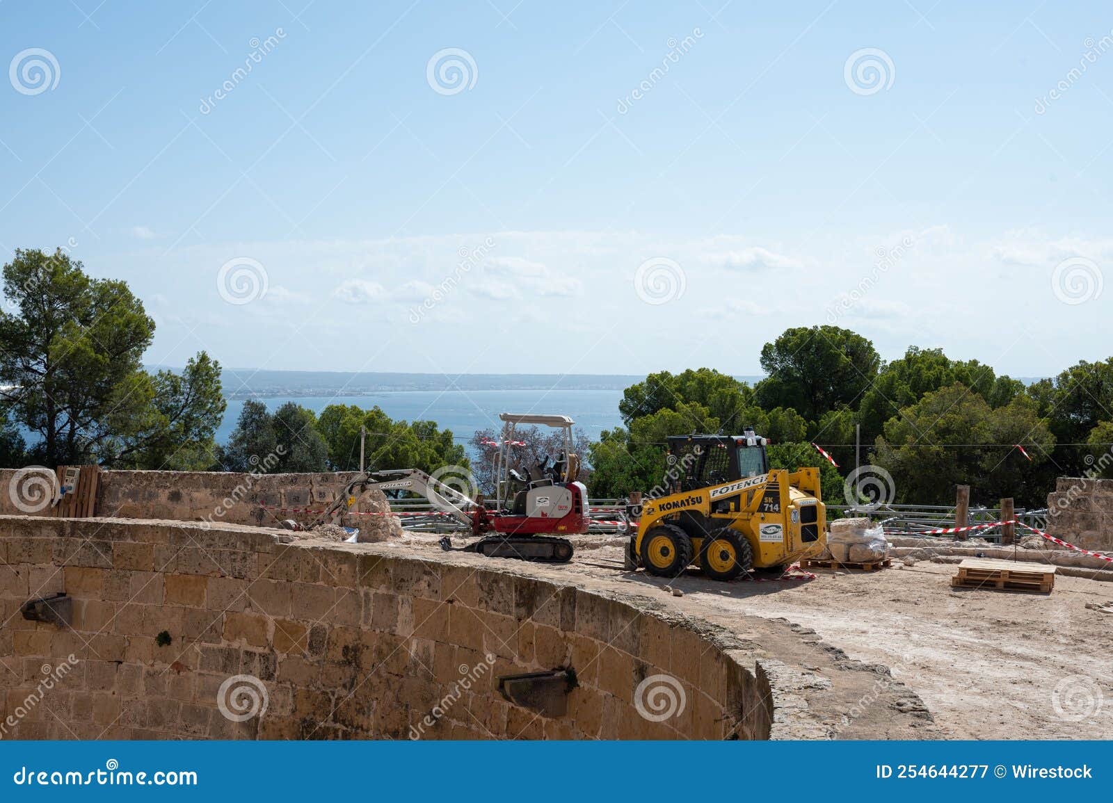 Side View of a Mini Excavator and a Skid Steer Loader at the ...