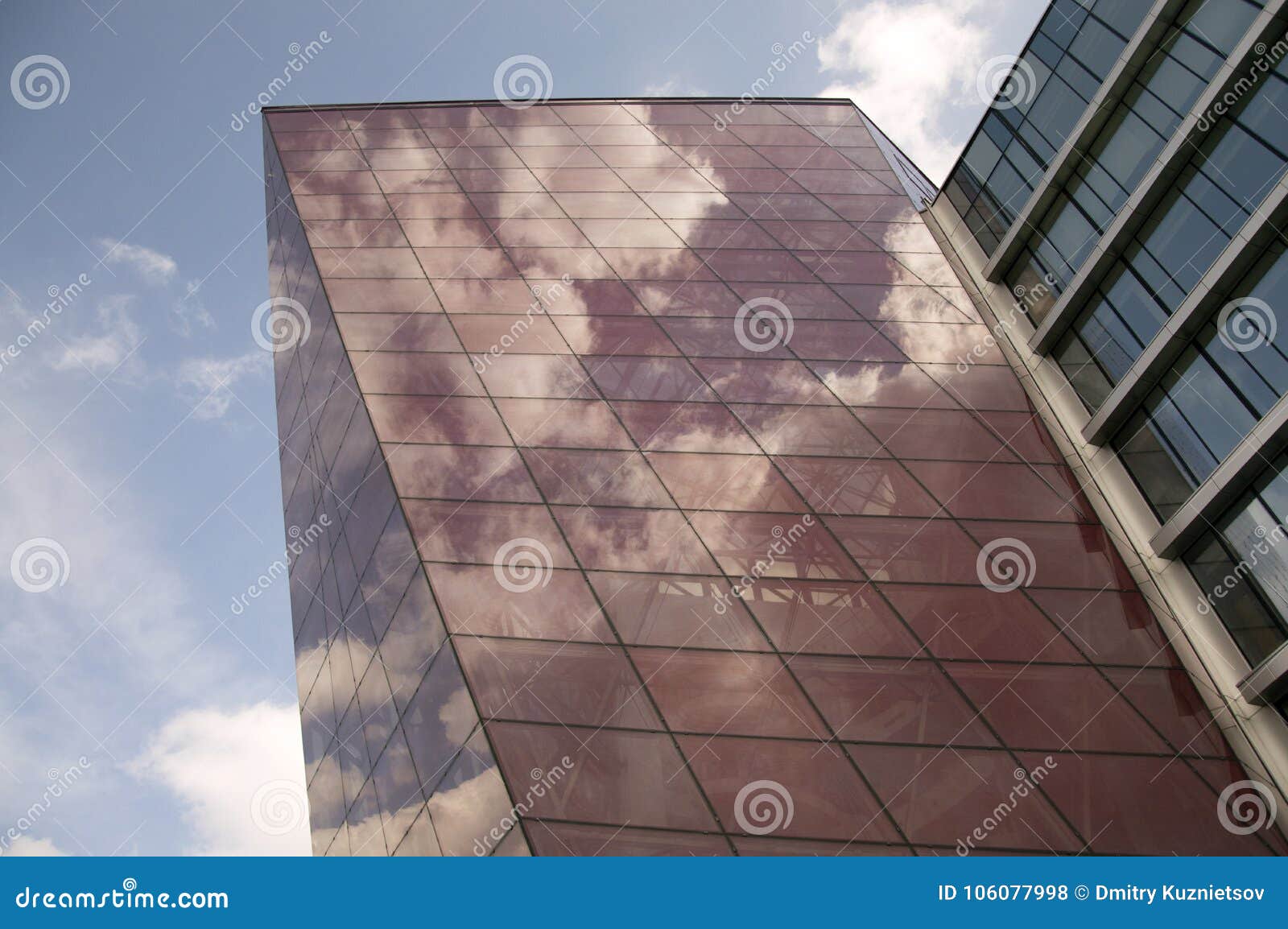Side View of the Modern Building Facade with Clouds Reflections on the ...