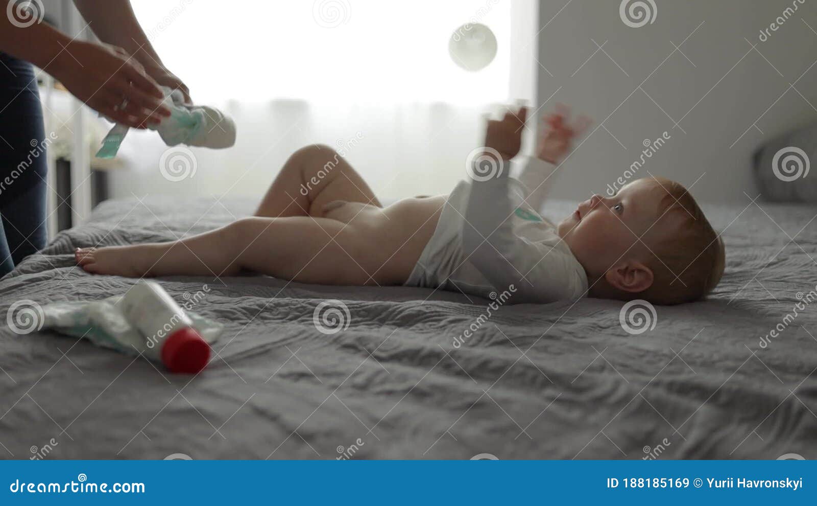 Side View. Mom Changes Baby`s Diaper on the Bed Stock Video - Video of ...