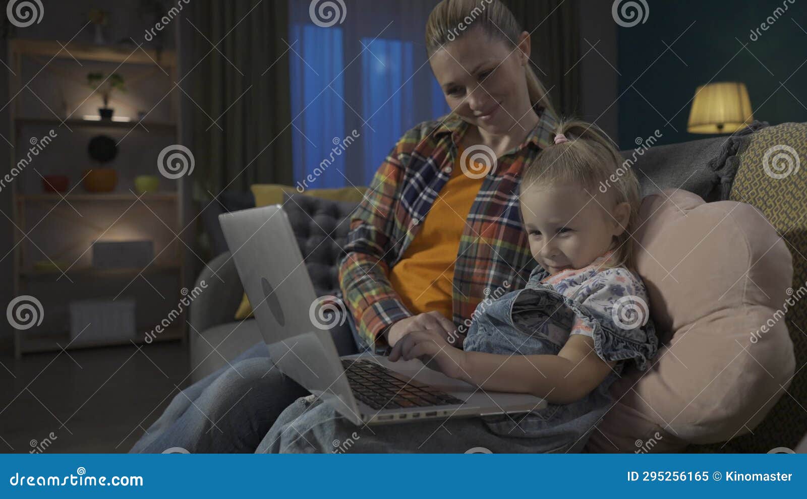 Side View Of A Mom Teaching Her Daughter How To Use Computer