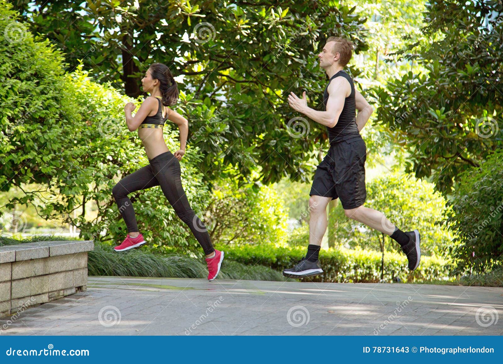 Side View of Multi Ethnic Couple Running in Park Stock Image - Image of ...