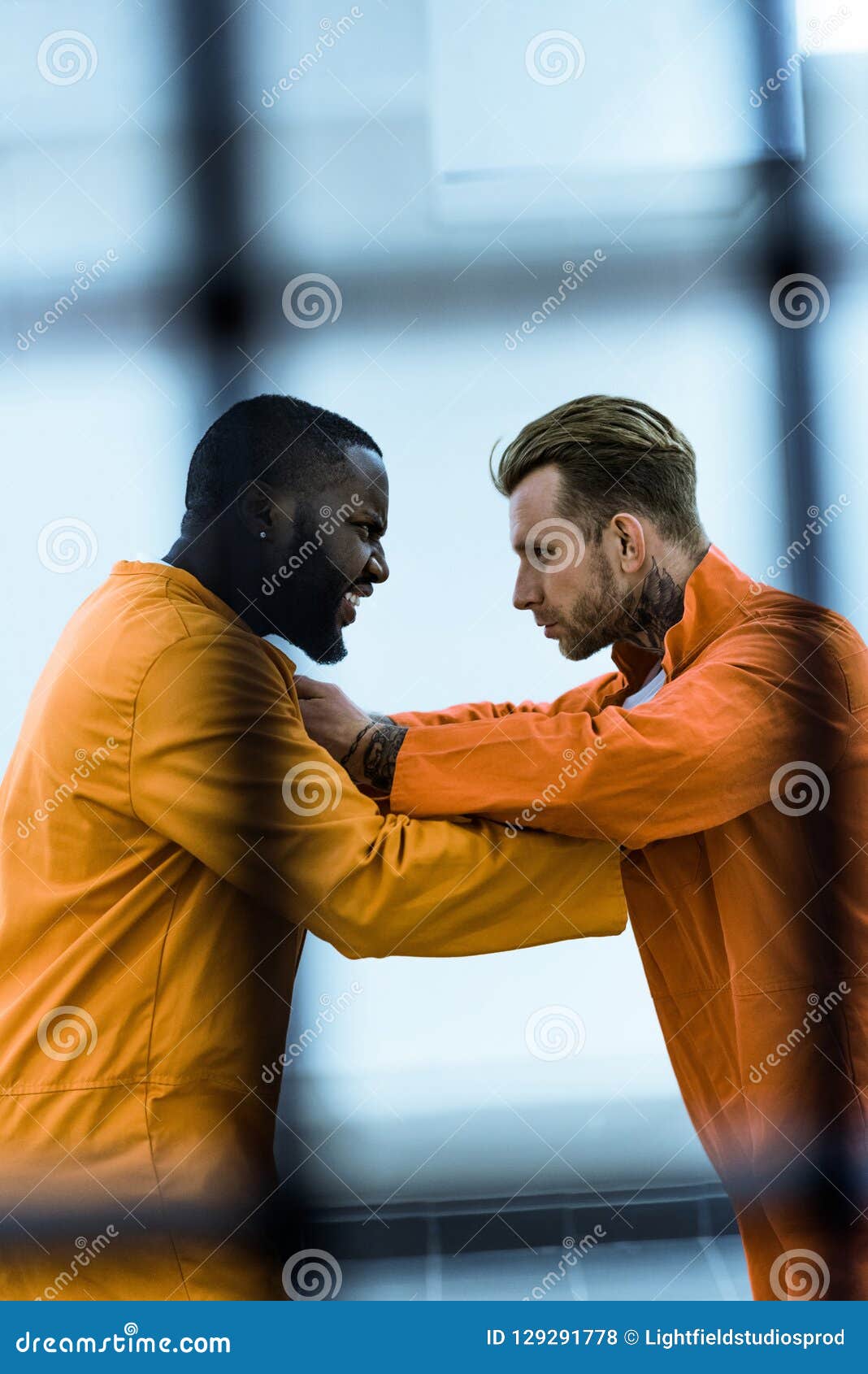 Side View of Multicultural Prisoners Threatening Each Other Stock Photo ...