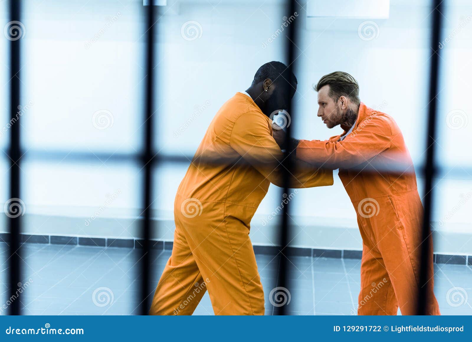 Side View of Multiethnic Prisoners Fighting Behind Stock Photo - Image ...
