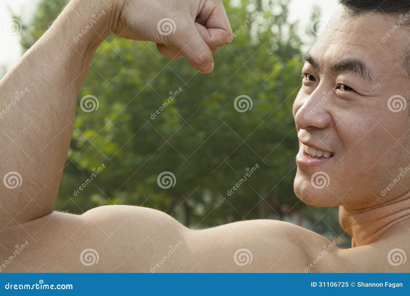 Side View Of Muscular Smiling Man Showing Off And Flexing His Bicep ...