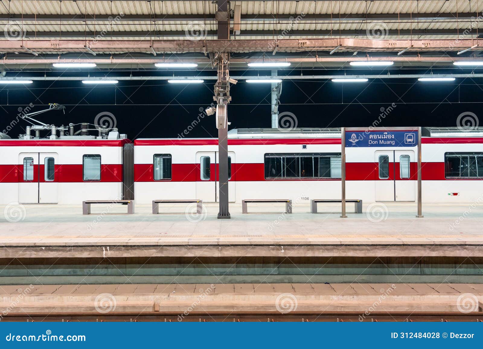 Side View of the Night Time Station Platform and Commuter Train in the ...