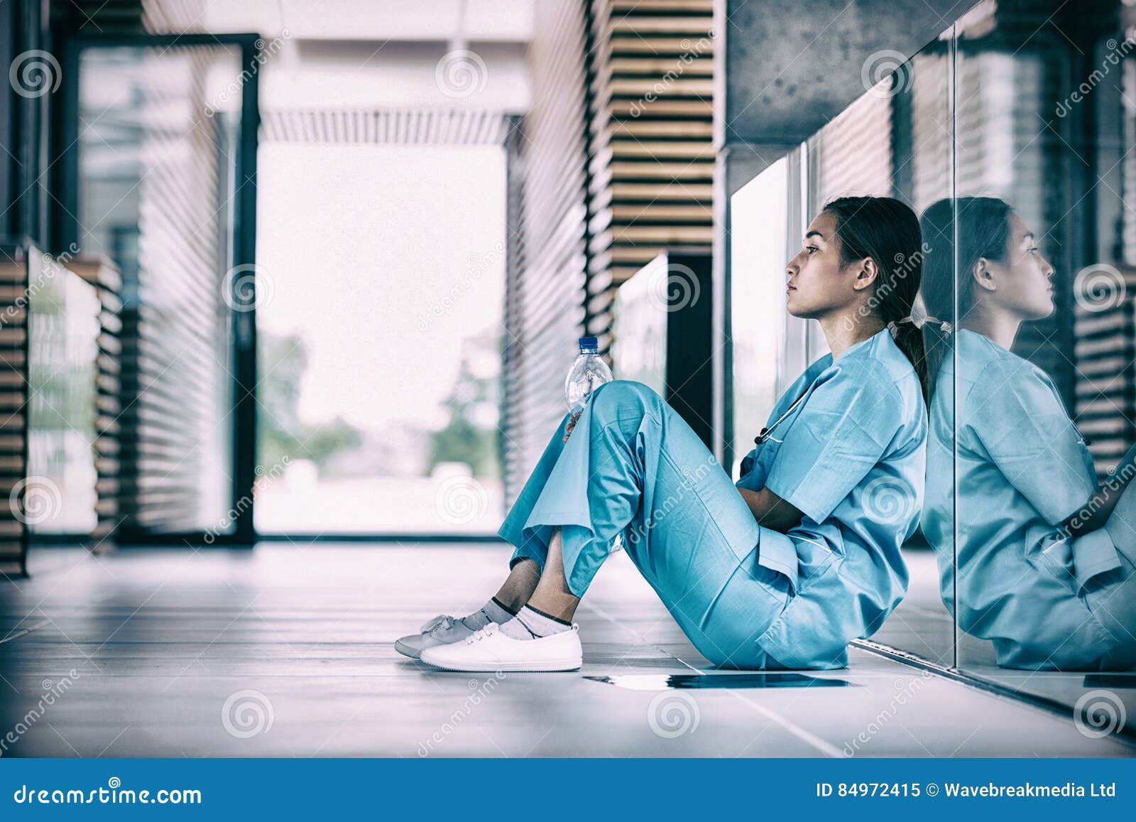 Side View of Nurse Sitting on Floor Stock Image - Image of chart, floor ...
