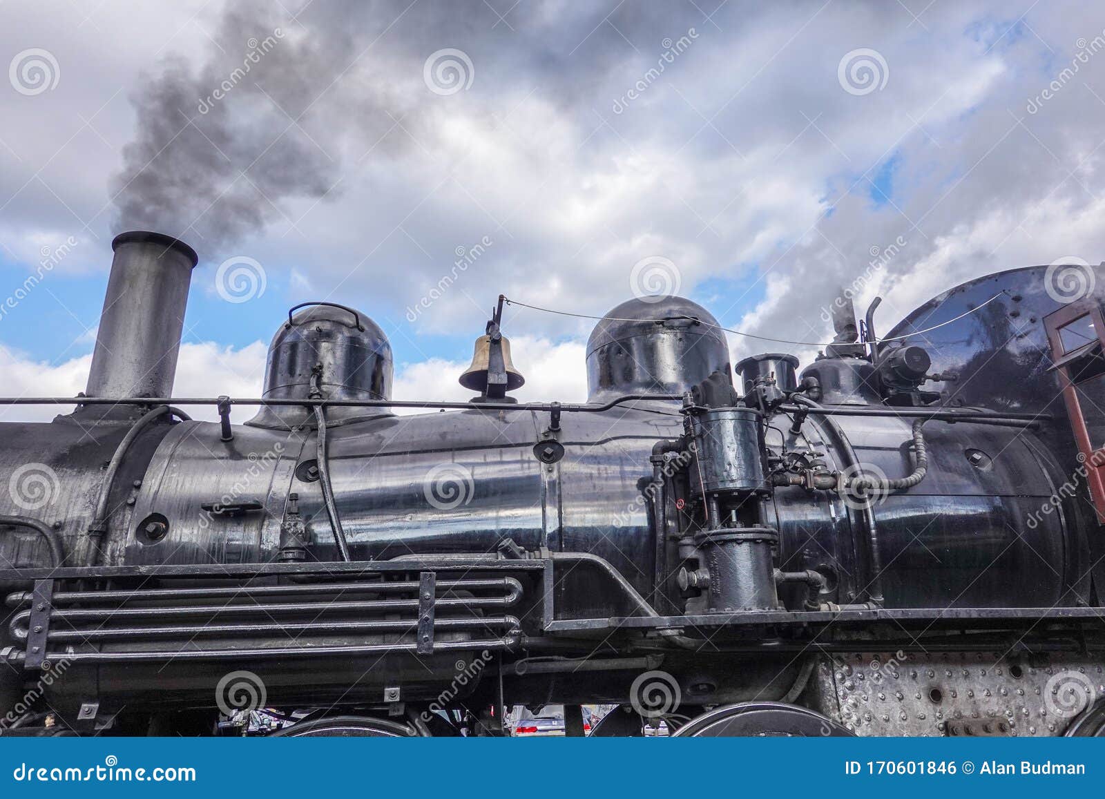 Side View of an Old Steam Locomotive Engine with Smoke Coming from the ...