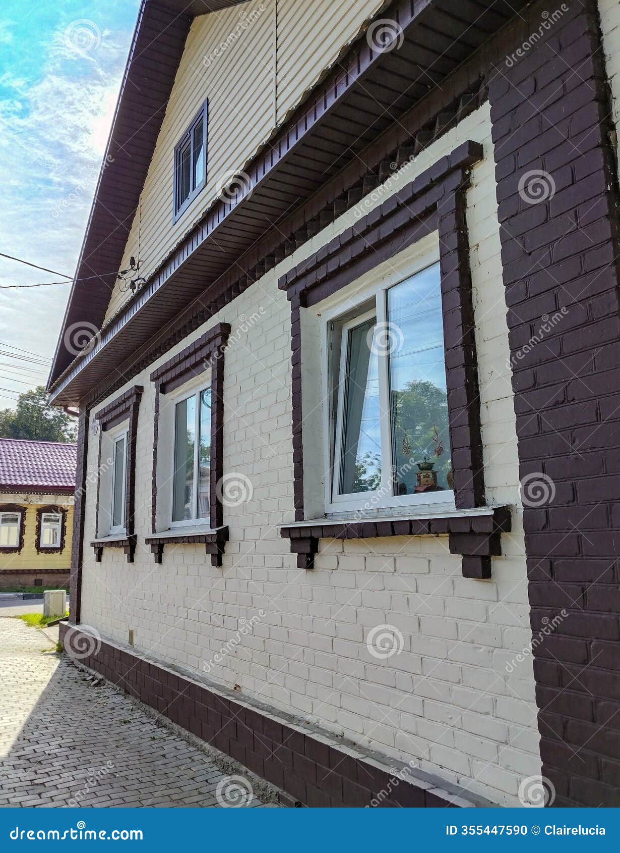 Side View of a One-story Brick House with Three Plastic Windows and a ...