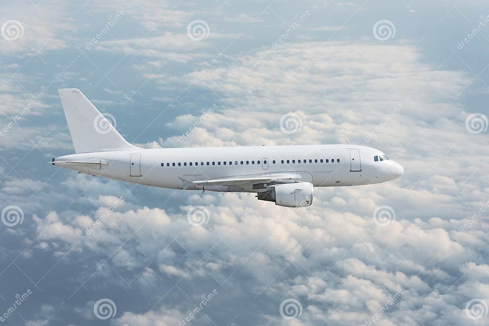 Side View of a Passenger Jet Liner Flying in the Clouds Stock Image ...