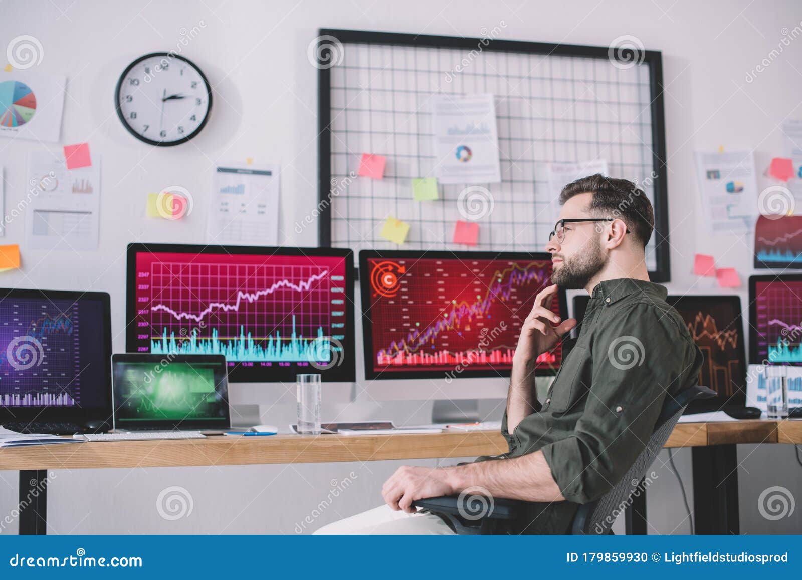 Side View of Pensive Data Analyst Looking Away Near Charts on Computer ...