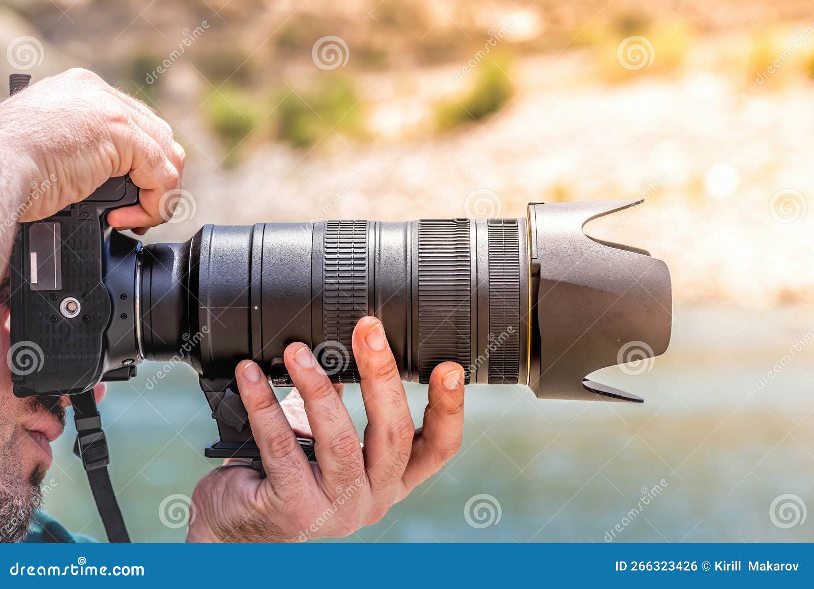 Side View of a Photographer Holding Camera Stock Photo - Image of ...