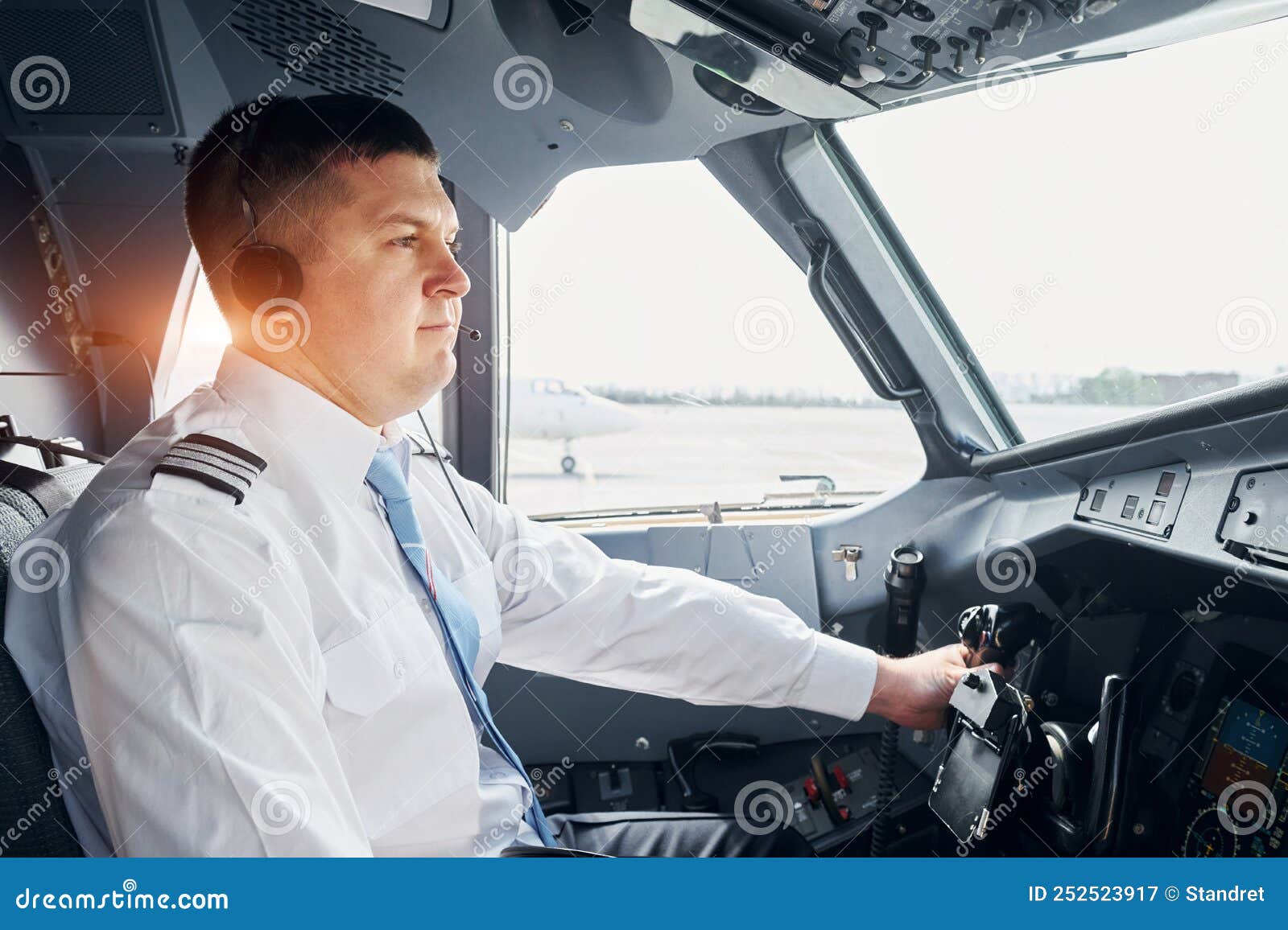 Side View. Pilot in Formal Wear Sits in the Cockpit and Controls ...