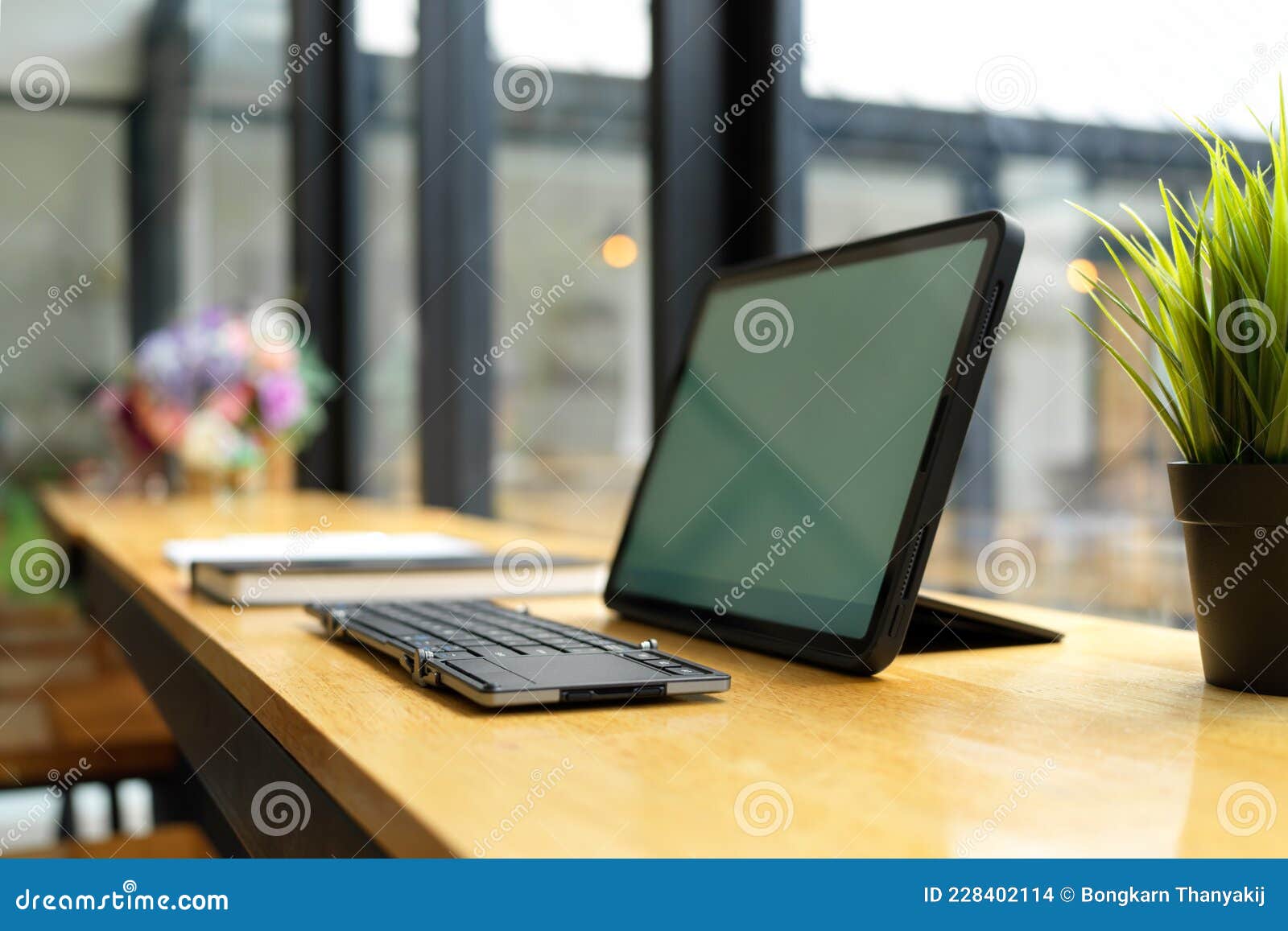 Side View, Portable Tablet with Magic Keyboard Standing on Wooden Table ...