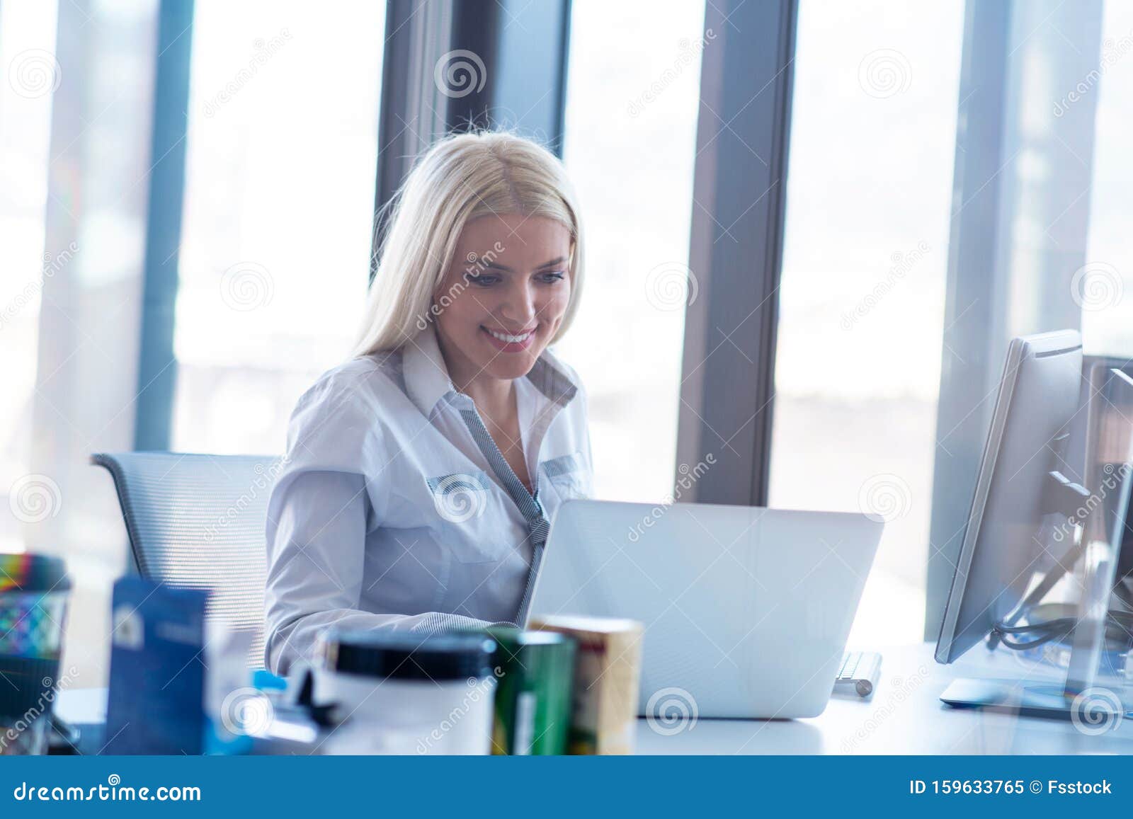 Side View Portrait of Businesswoman Using Computer at Office Desk Stock ...