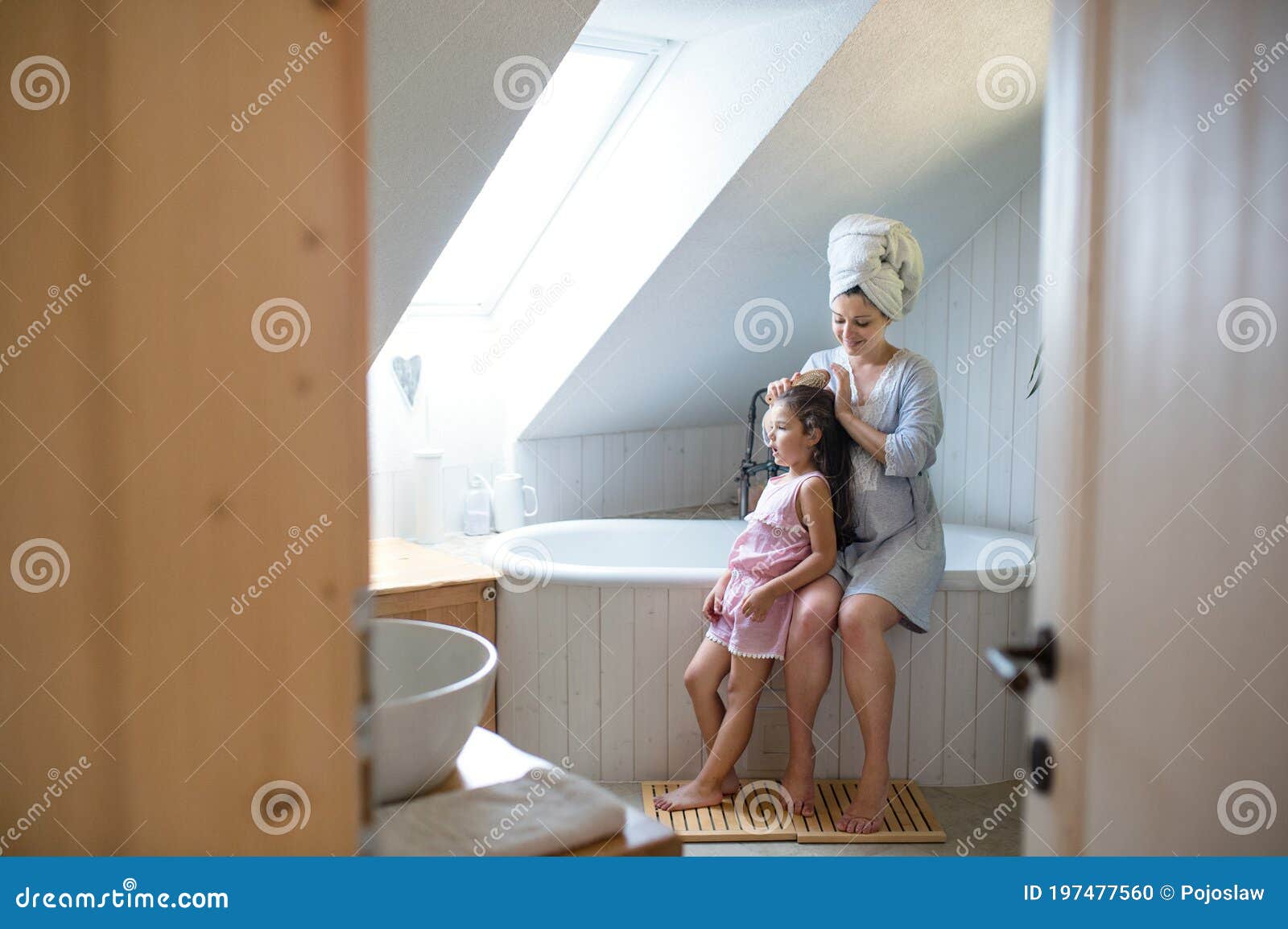 Portrait Of Pregnant Woman With Small Daughter Indoors In Bathroom At