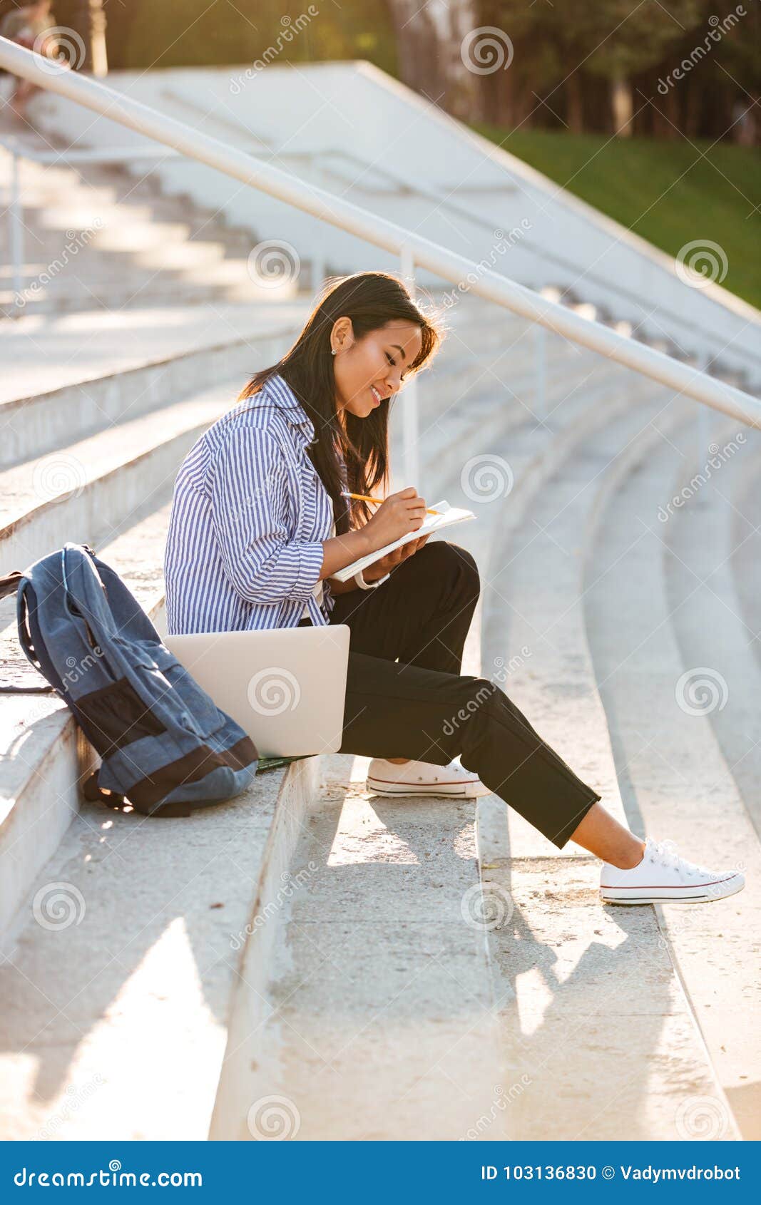 Side View Portrait of a Smiling Young Female Student Stock Photo ...