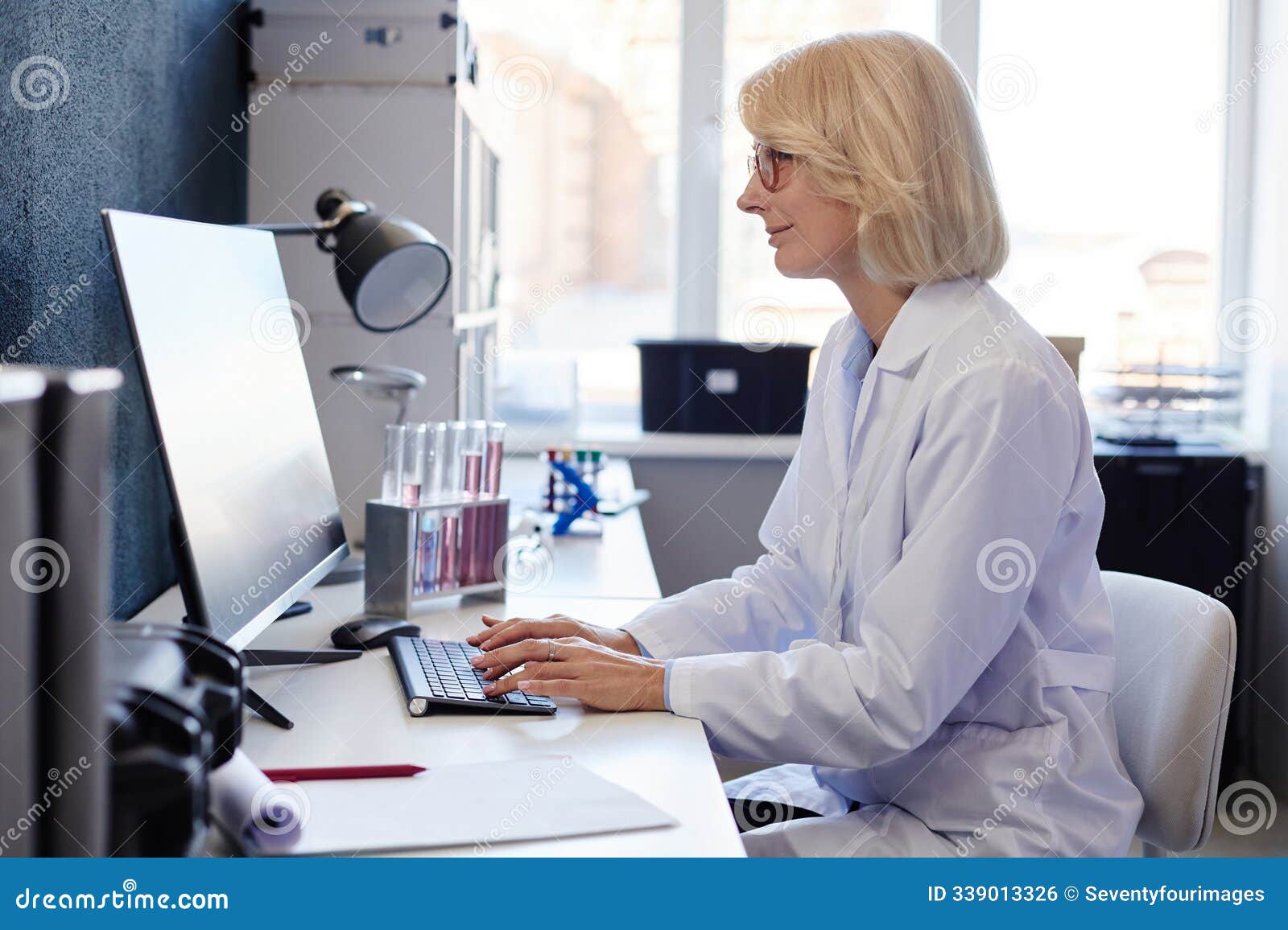 Female Lab Chemist Using Computer while Studying Chemicals in ...