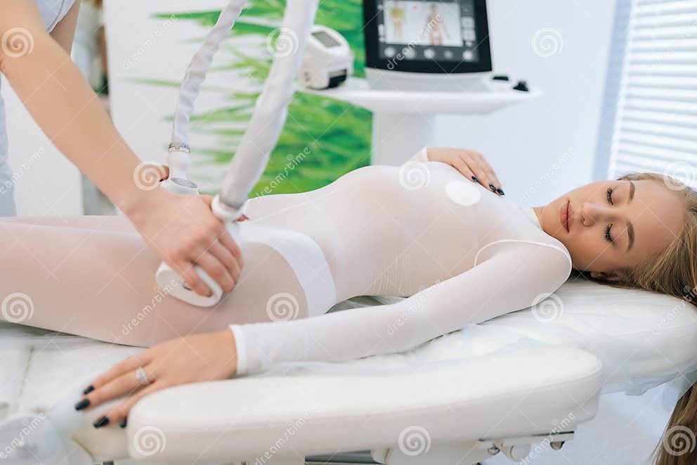 Side View Of Pretty Woman Client Getting Beauty Therapy Against