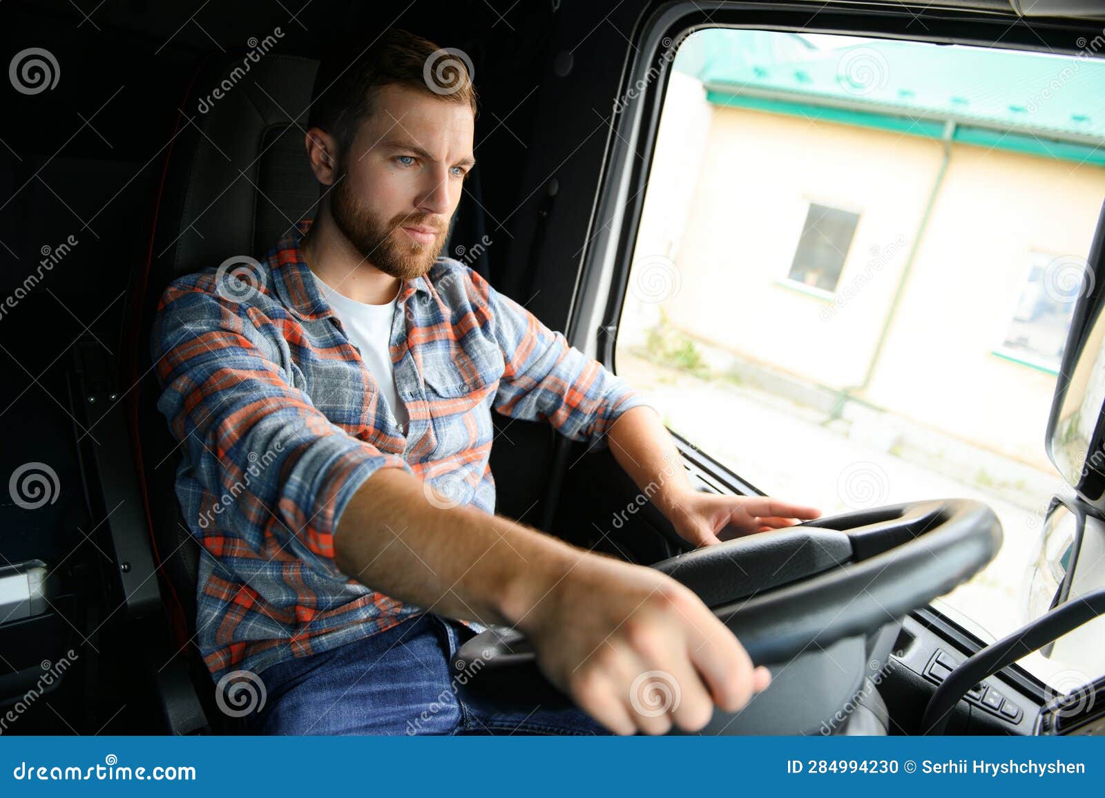 Side View of Professional Driver Behind the Wheel in Truck S Cabin ...