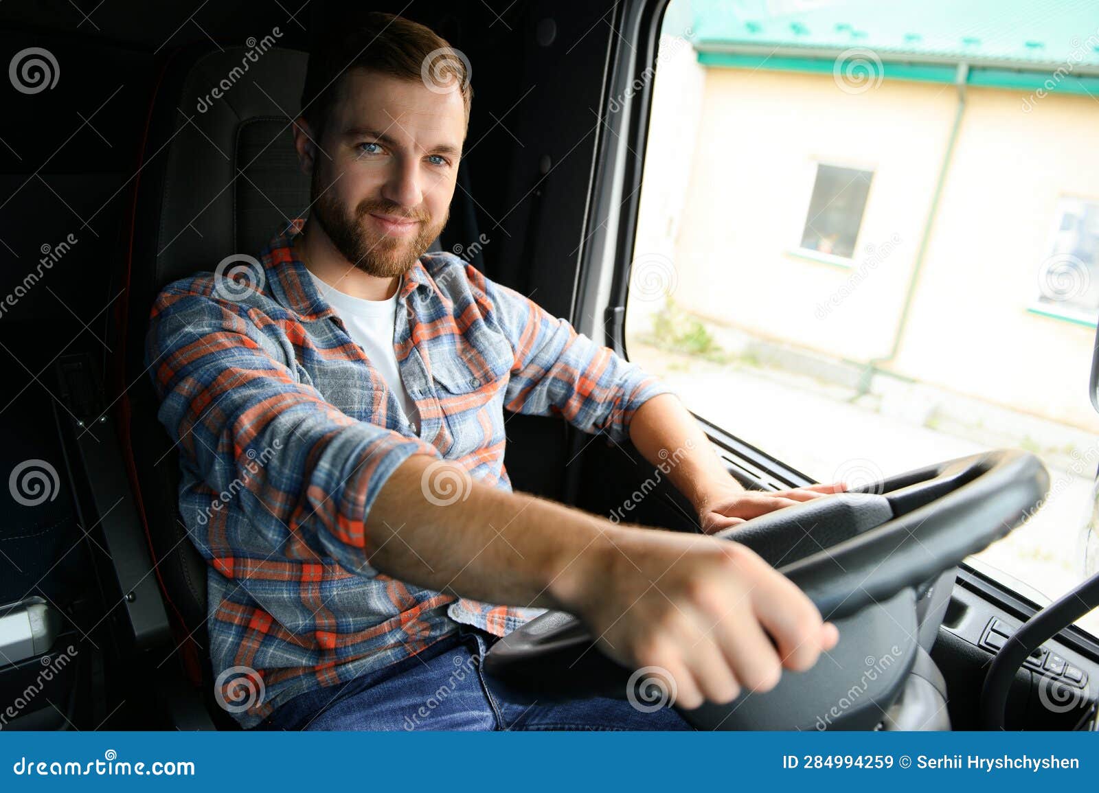 Side View of Professional Driver Behind the Wheel in Truck& X27;s Cabin ...