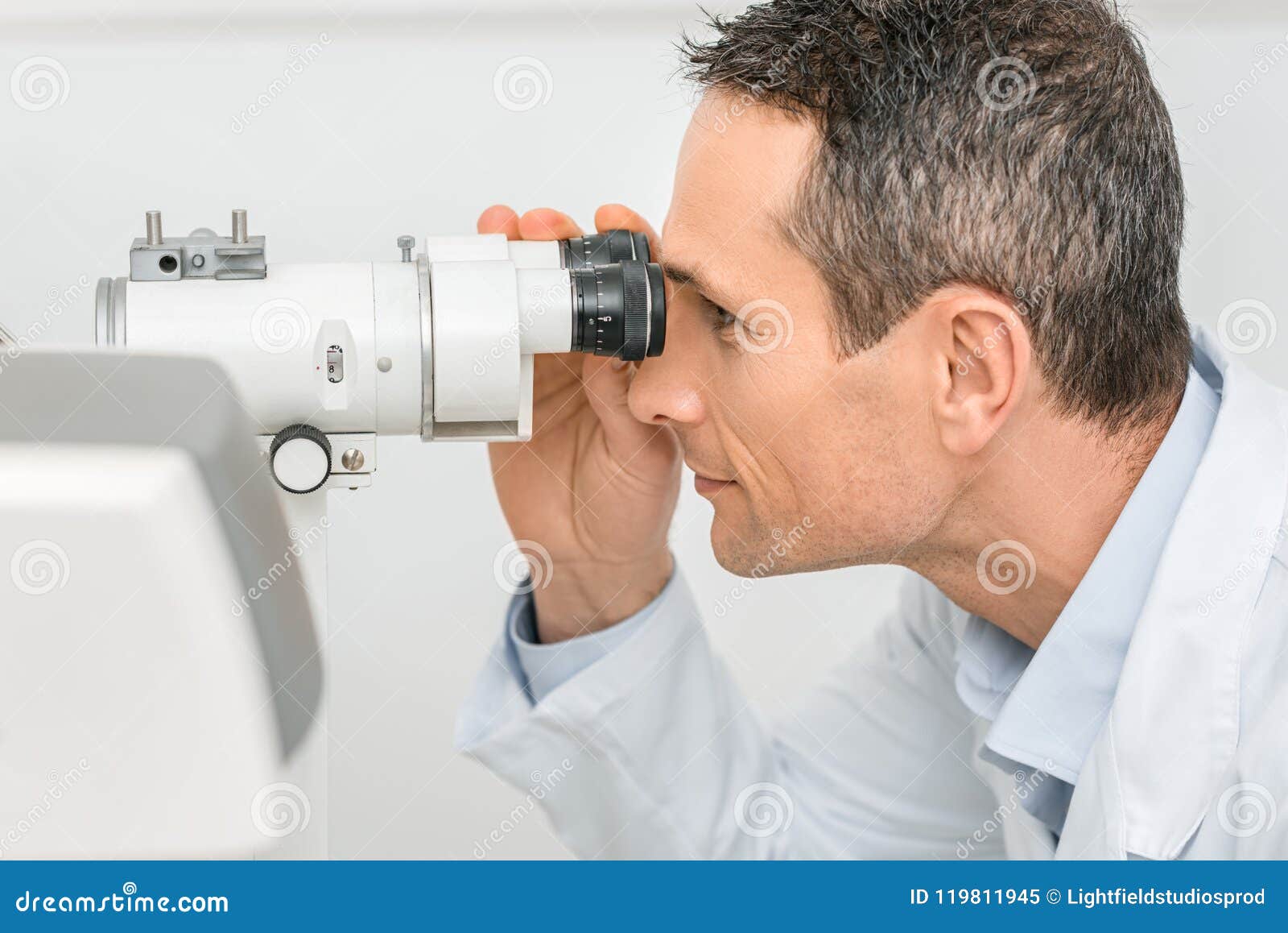Side View of Professional Optometrist Working with Slit Lamp Stock ...