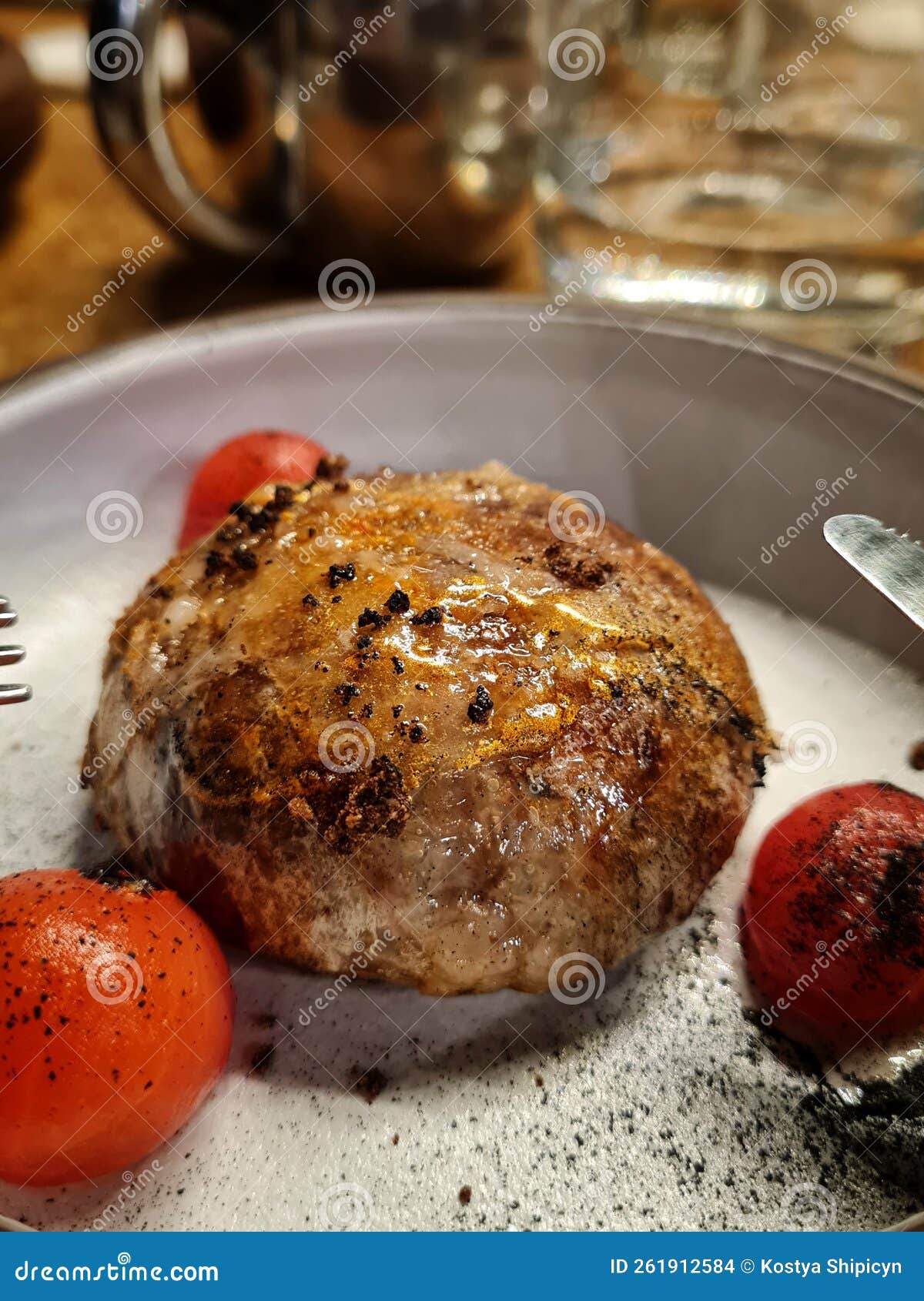Side View of a Round Piece of Roasted Meat on a Gray Plate Stock Photo ...