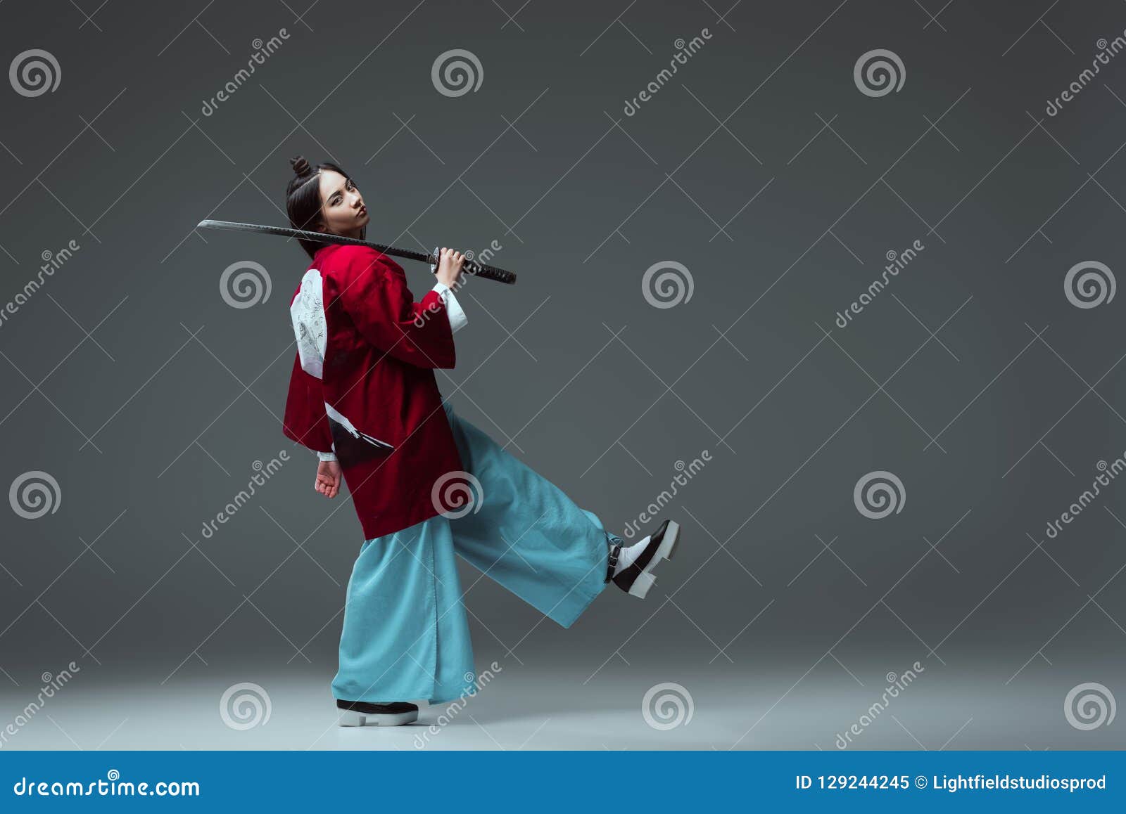 Side View of Samurai in Kimono Walking with Katana and Looking at ...
