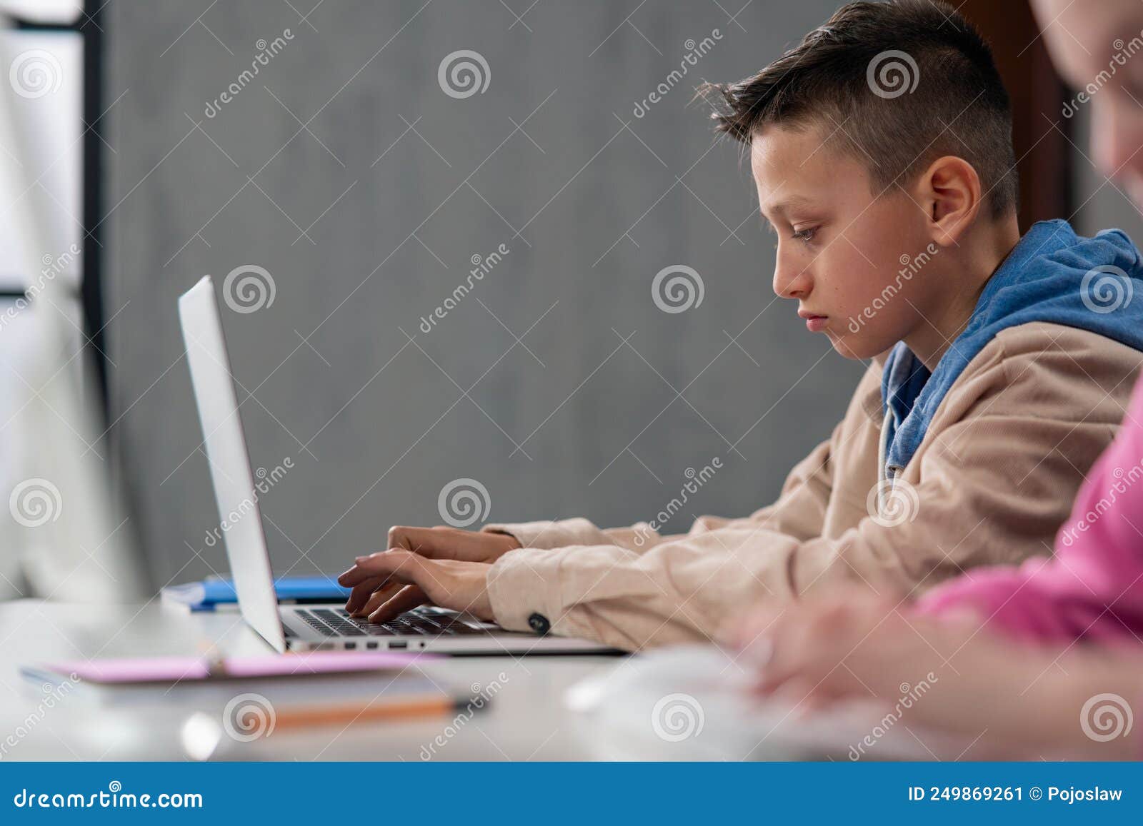 Side View of Schoolboy Using Computer in Classroom at School Stock ...