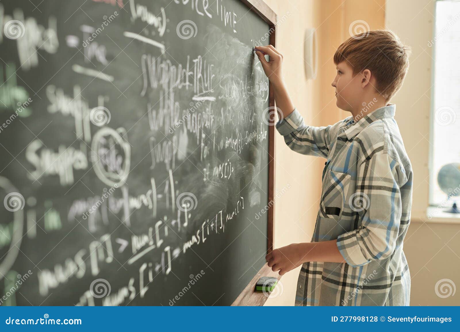 Side View Schoolboy Writing on Blackboard in Class Stock Photo - Image ...