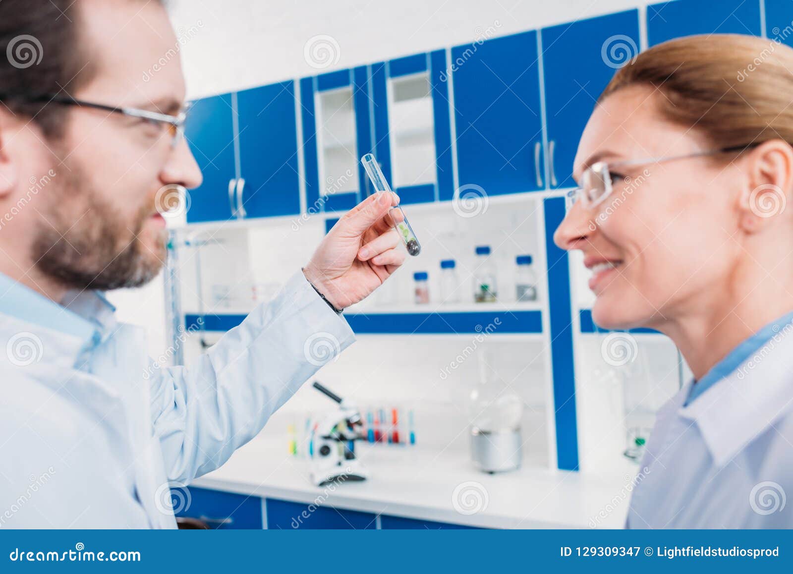 Side View of Scientists in Eyeglasses with Tube with Reagent Stock ...