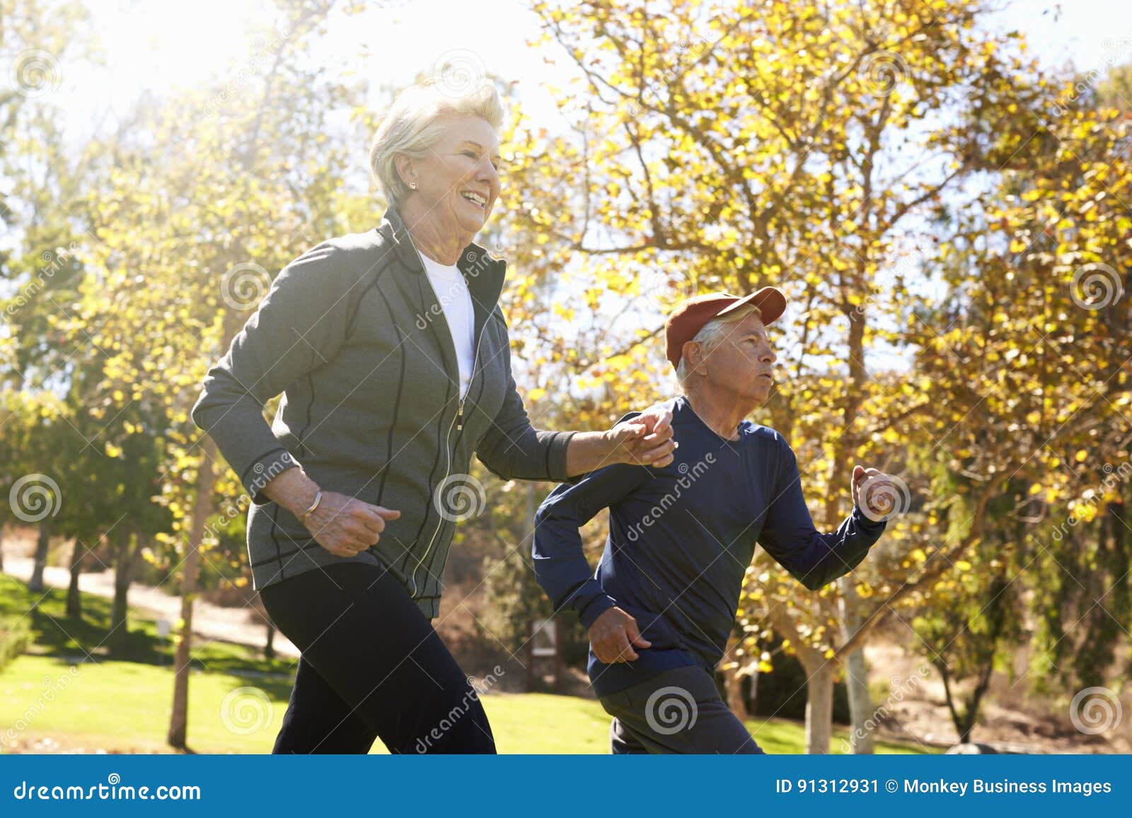 Side View of Senior Couple Power Walking through Park Stock Image ...