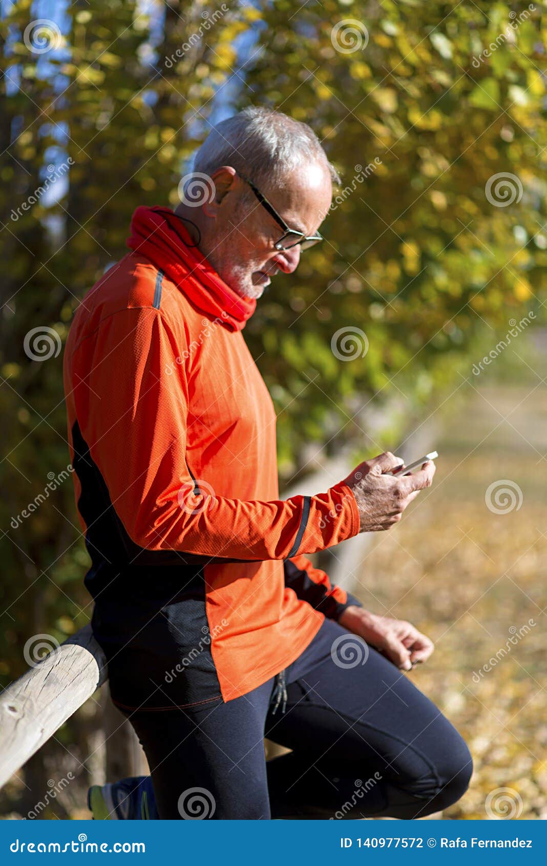 Side View of a Senior Runner Man Leaning on Fence while Testing ...