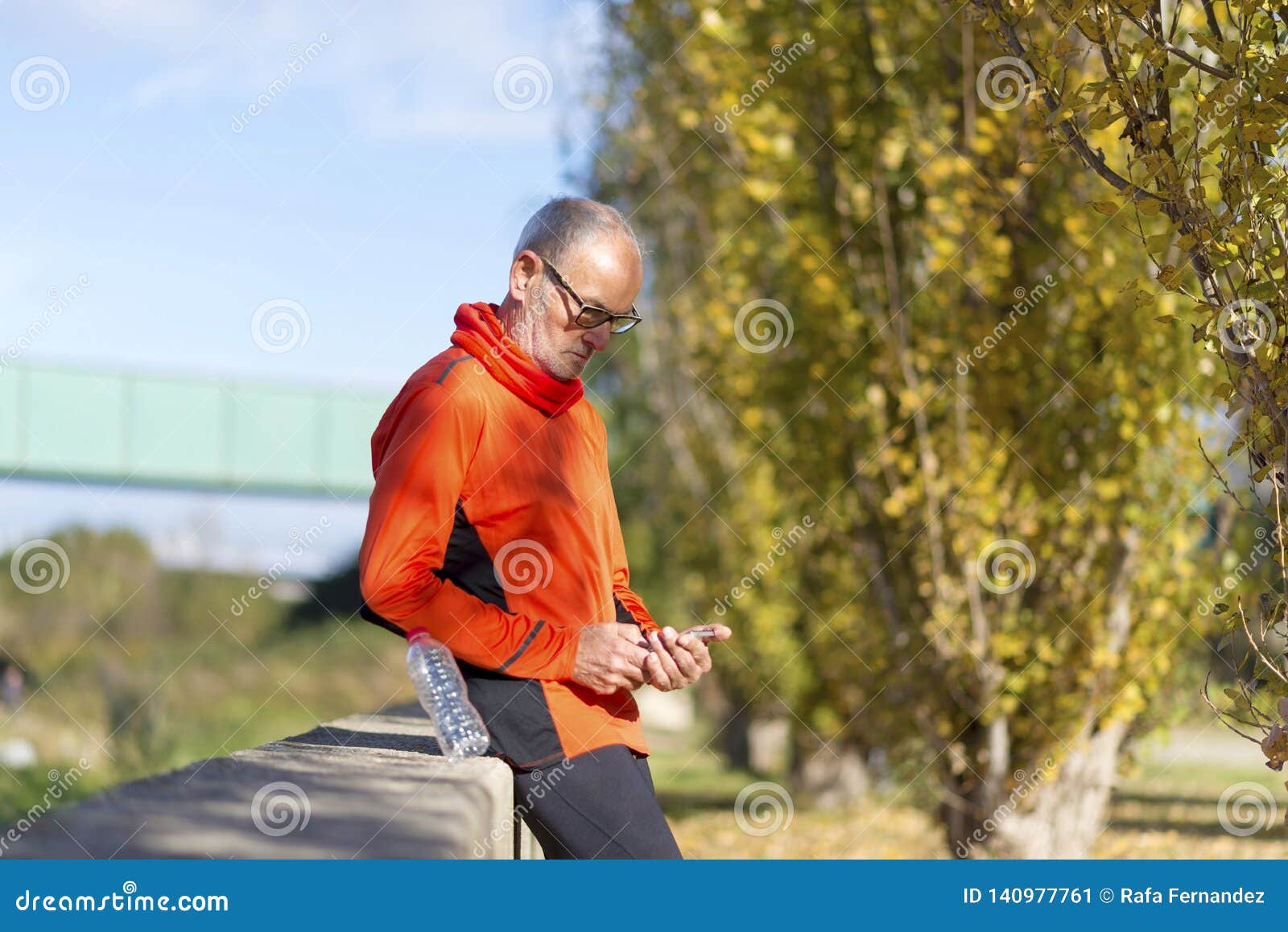 Side View of a Senior Runner Man Leaning on Fence while Testing ...