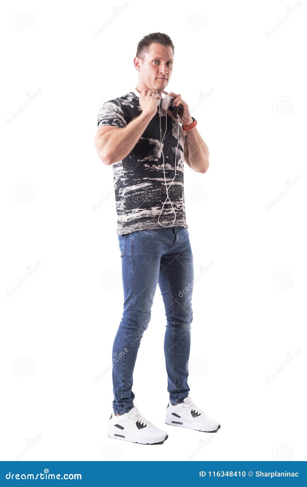 Side View of Serious Confident Man Holding and Put on Headphones ... Side View of Serious Confident Man Holding and Put on Headphones ...