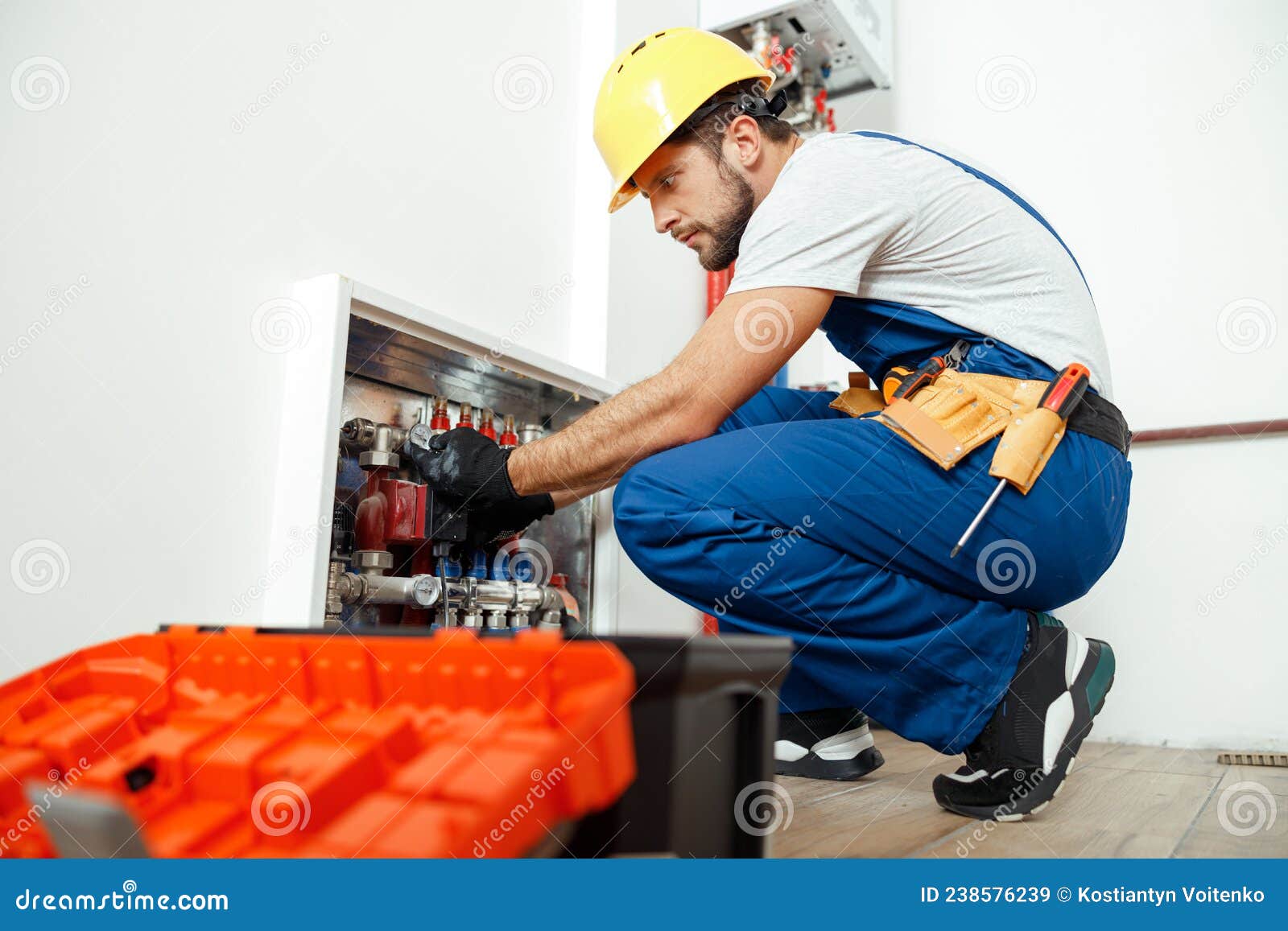 Side View of Serious Technician, Plumber in Uniform Using Tools from ...