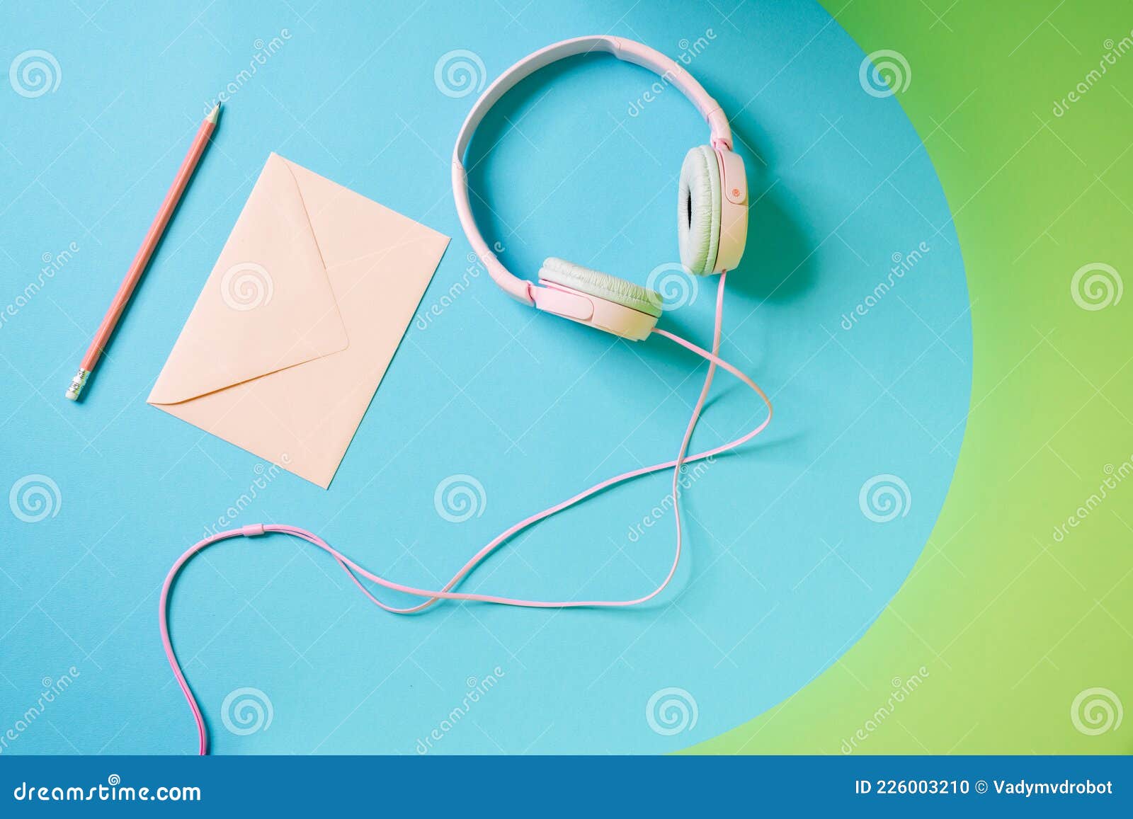 The Side View of a Set of Headphones, Writing and a Pencil Lying in a ...