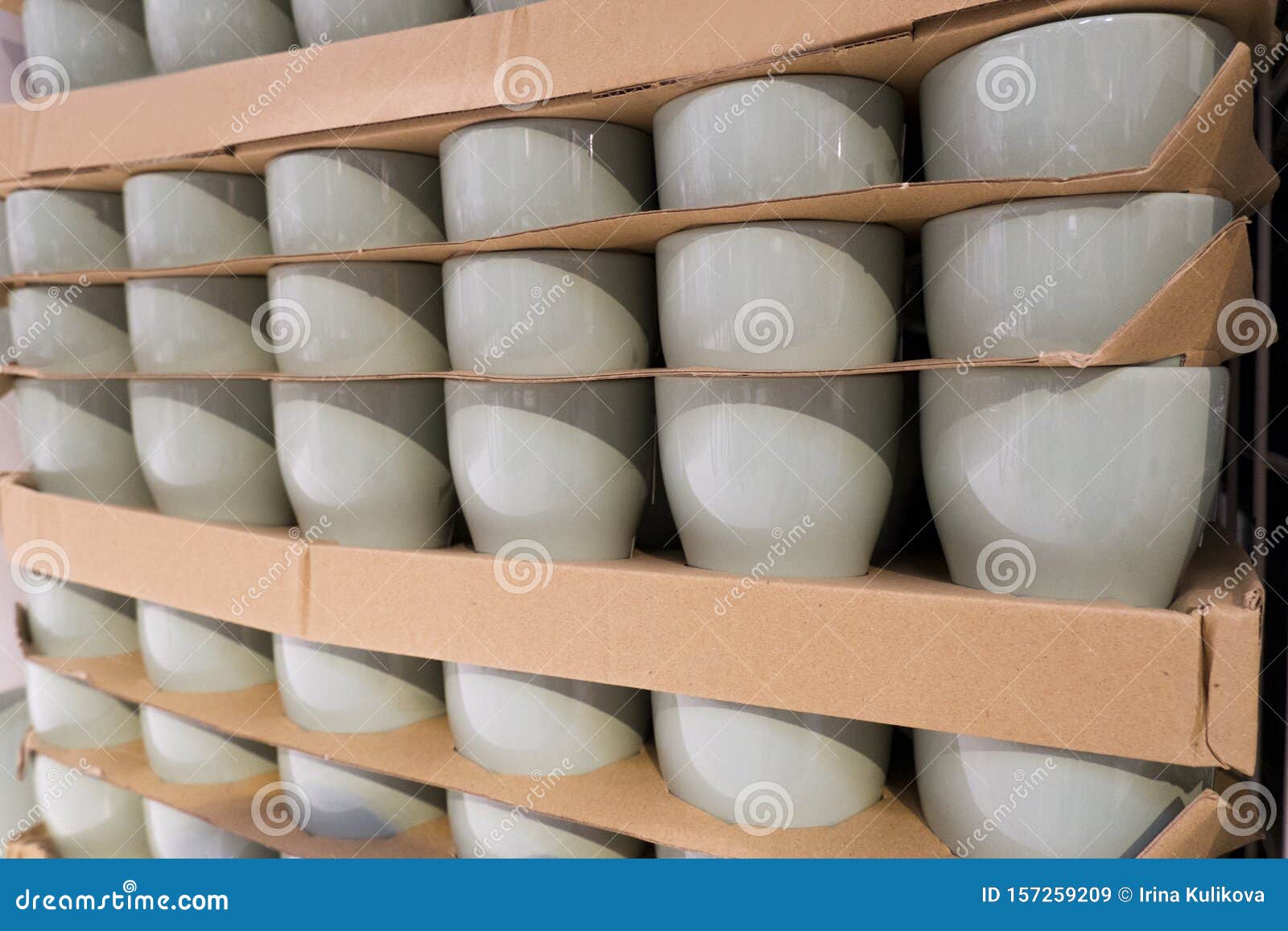 Several Rows of Gray-green Ceramic Containers in Cardboard Packaging on ...
