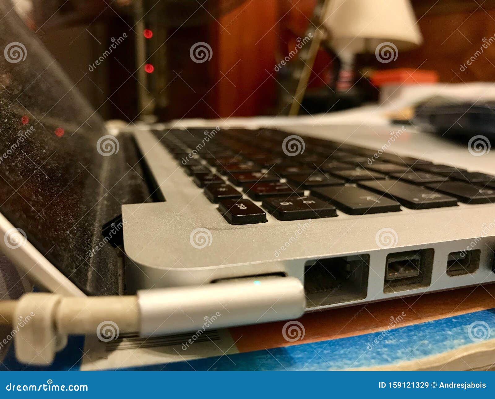 View of a Silver Metallic Laptop Computer Over a Drawing Notebook on ...