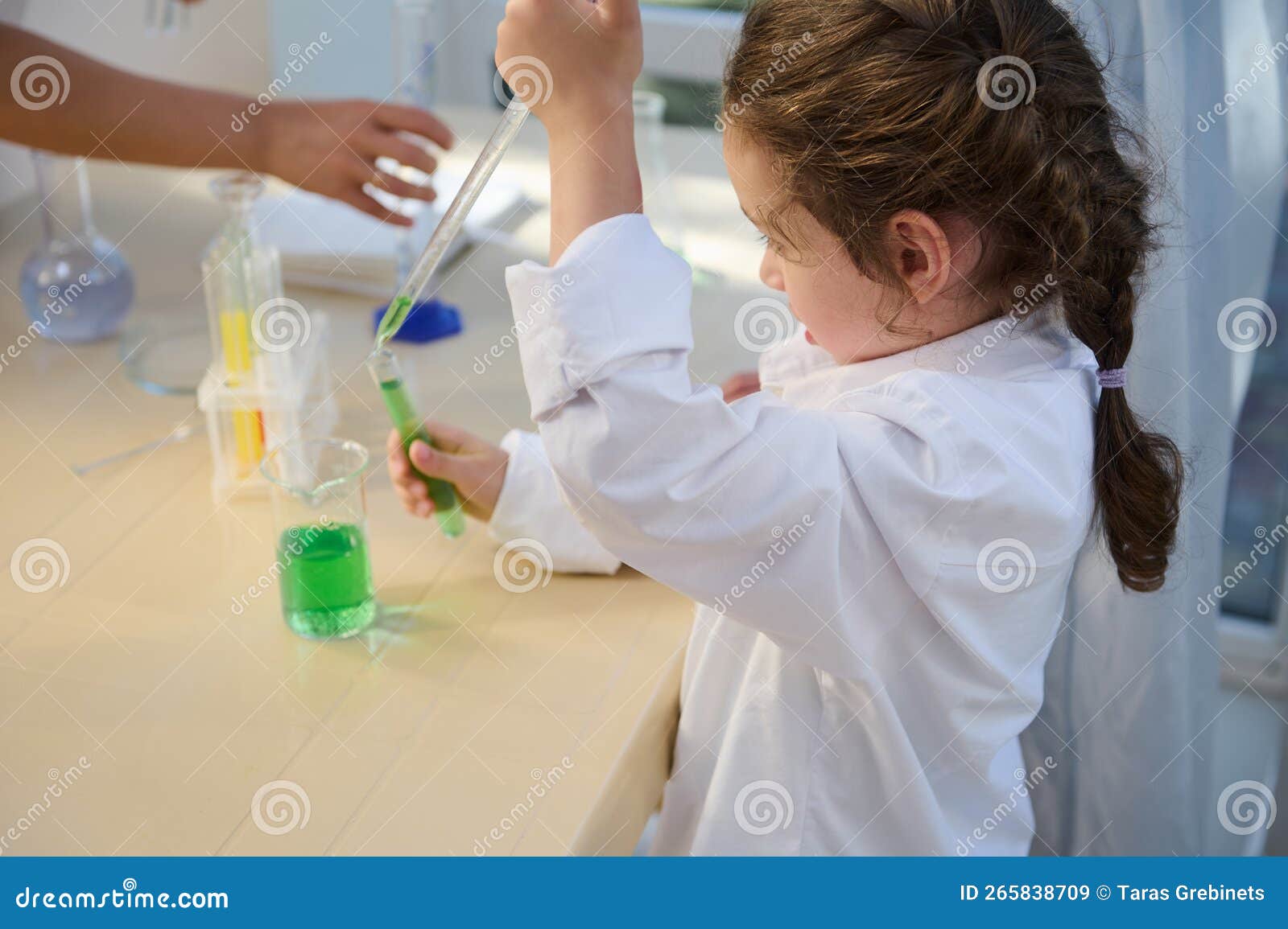 Side View of Smart Kid Using Graduated Pipette and Measuring Glassware ...