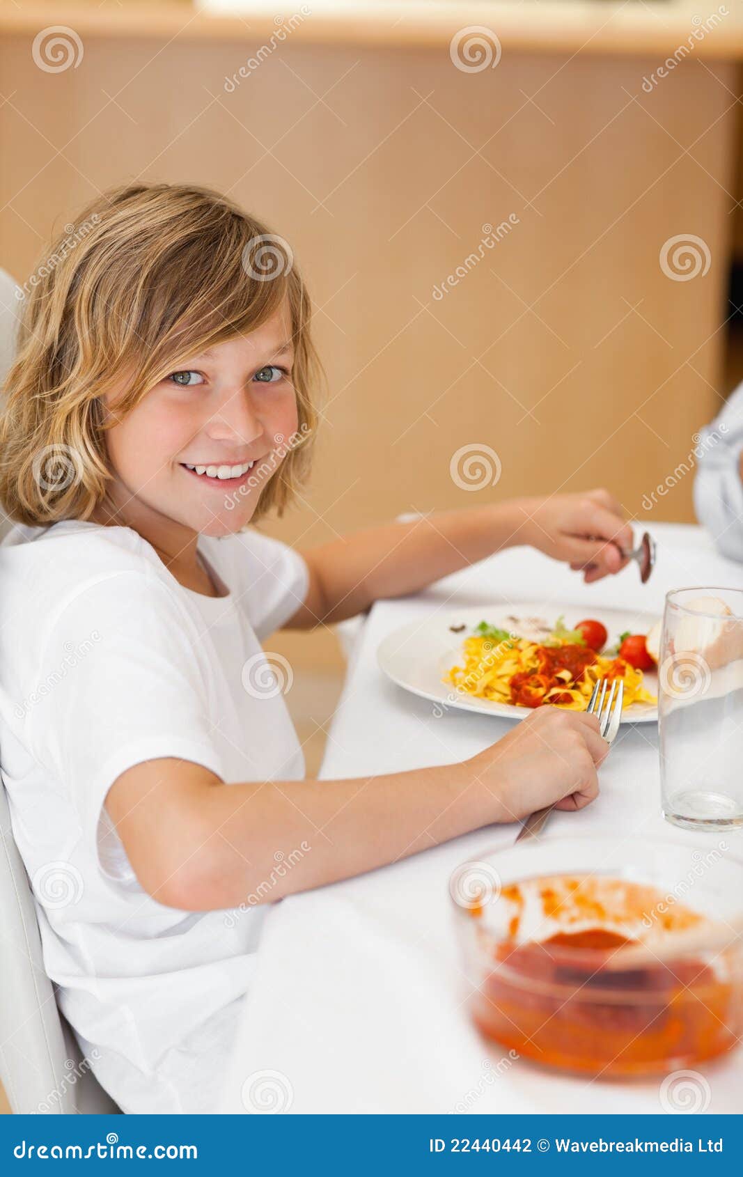 Side View of Smiling Boy at the Dinner Table Stock Photo - Image of ...