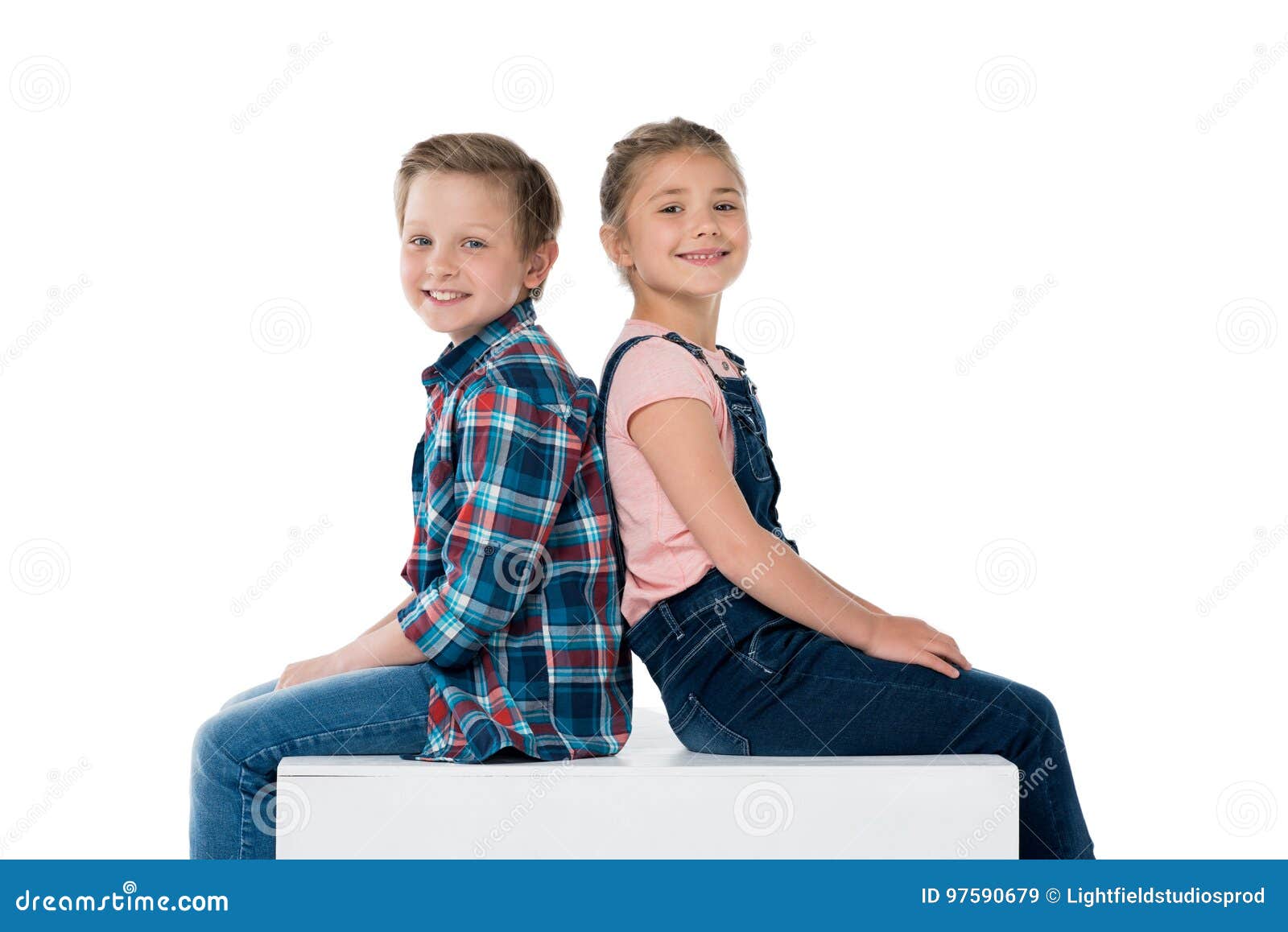 Side View of Smiling Children Sitting on Cube and Looking at Camera ...
