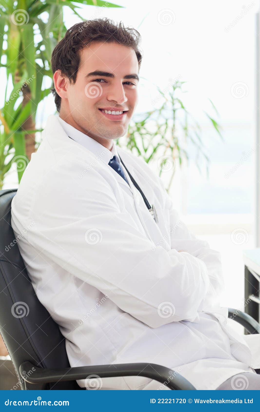 Side View of Smiling Doctor Sitting Stock Photo - Image of uniform ...