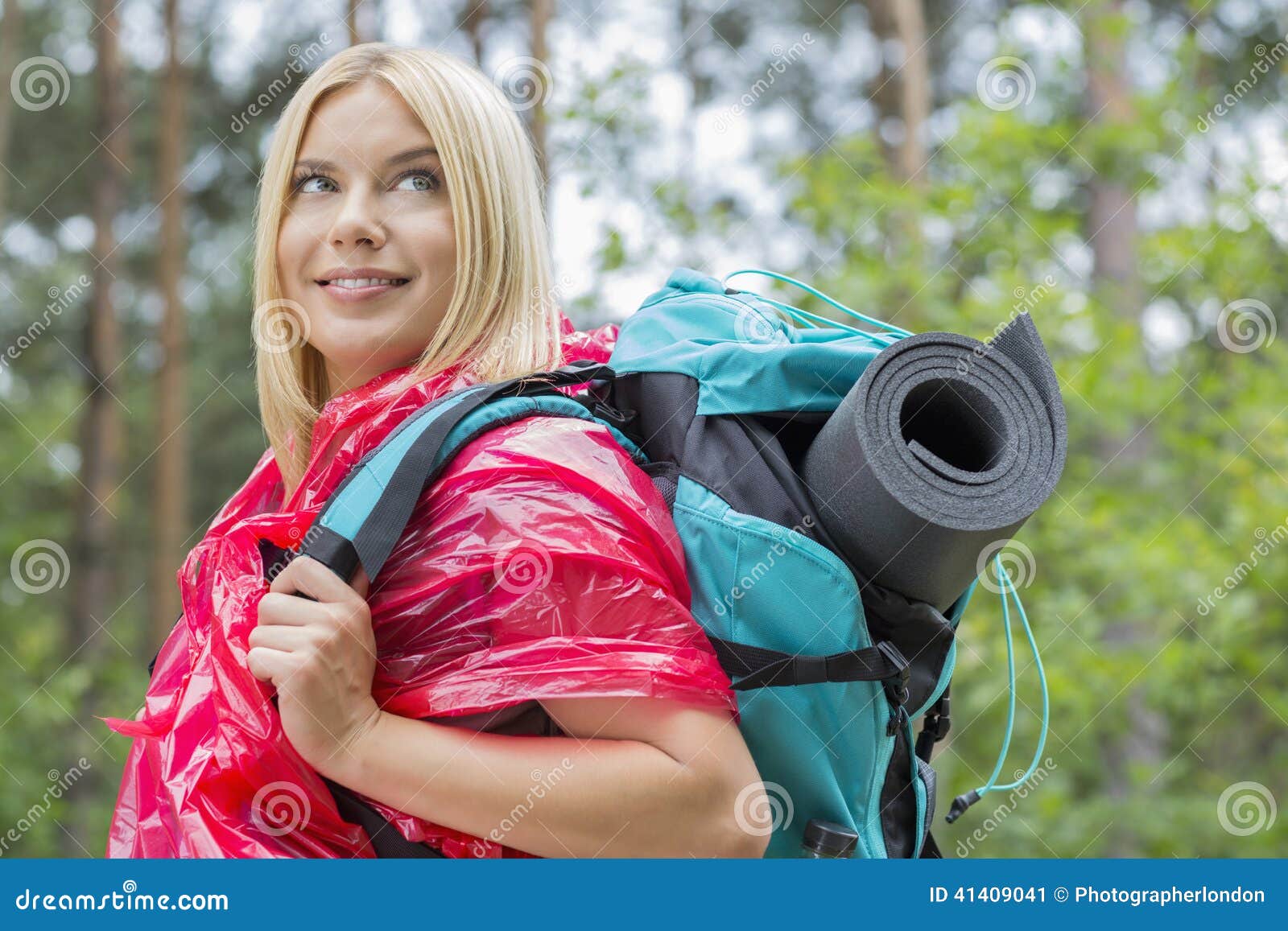 Side View Smiling Female Backpacker in Raincoat Looking Away at Forest ...