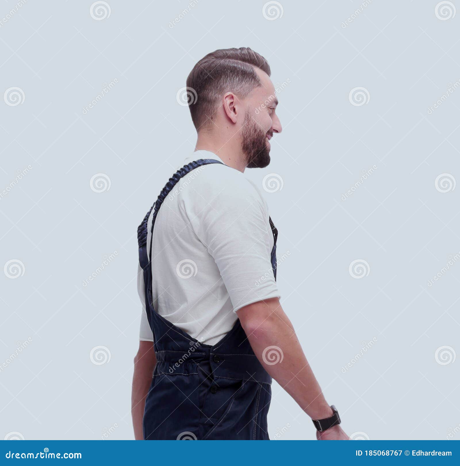 Side View. Smiling Man in Overalls Confidently Striding Forward Stock ...
