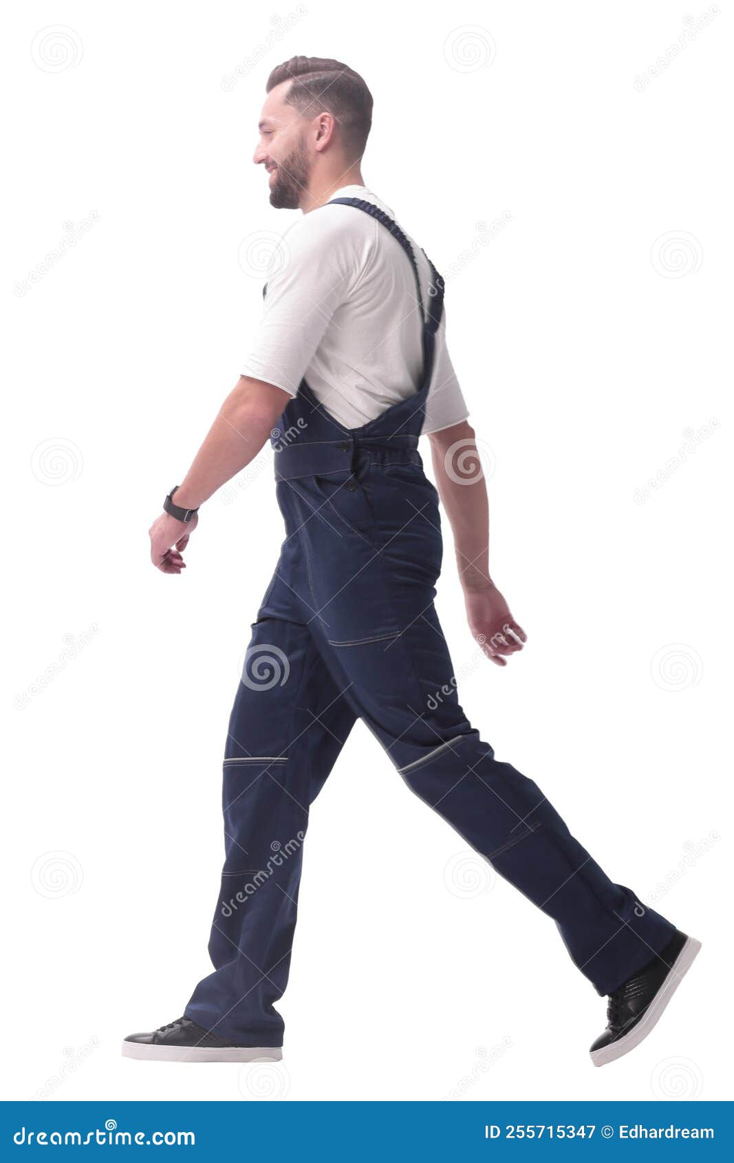 Side View. Smiling Man in Overalls Confidently Striding Forward Stock ...