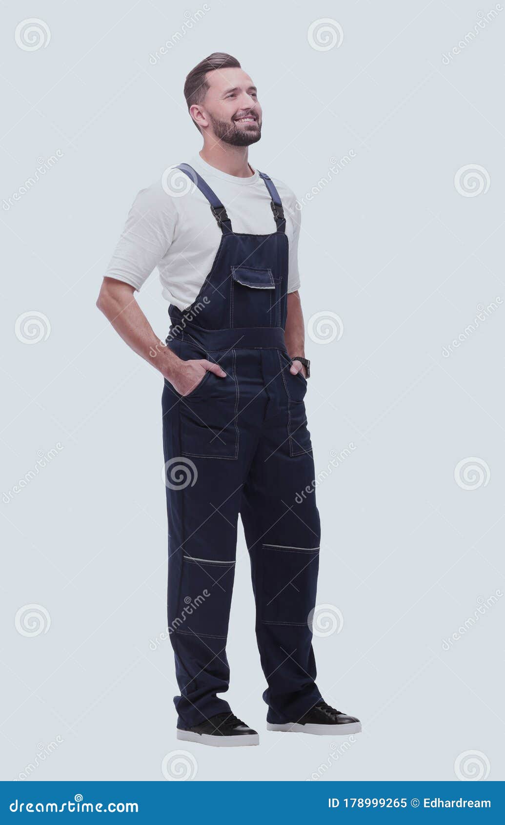 Side View. Smiling Man in Overalls Looking Forward To Copy Space Stock ...